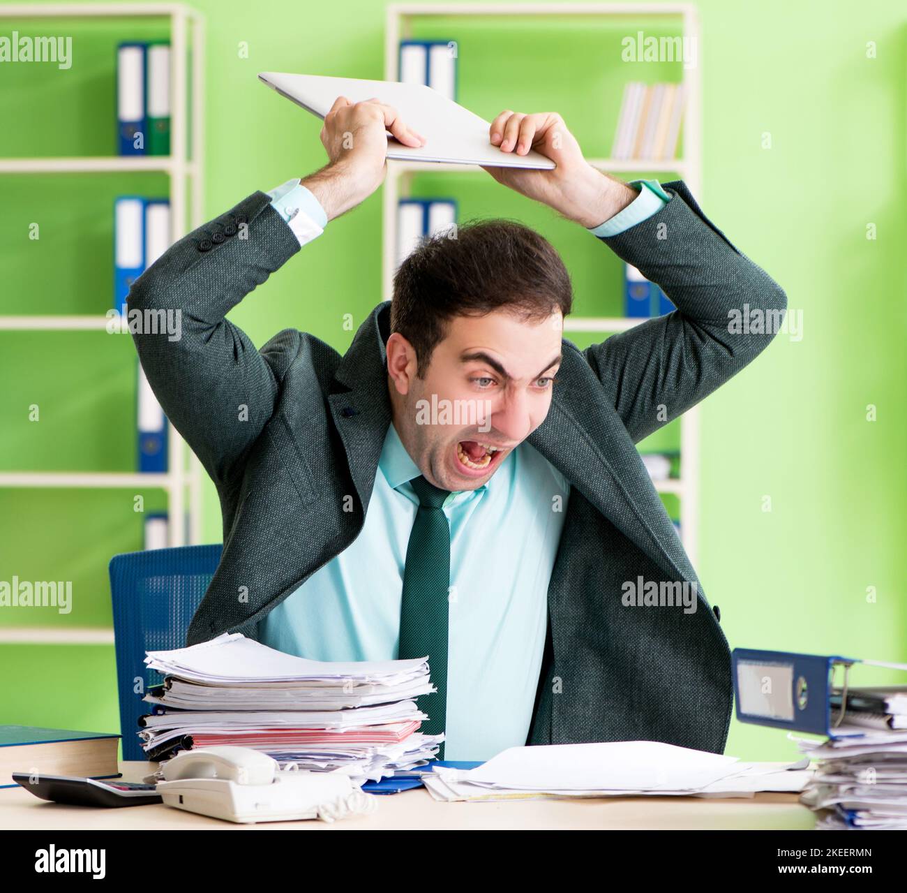 The businessman angry with excessive work sitting in the office Stock ...