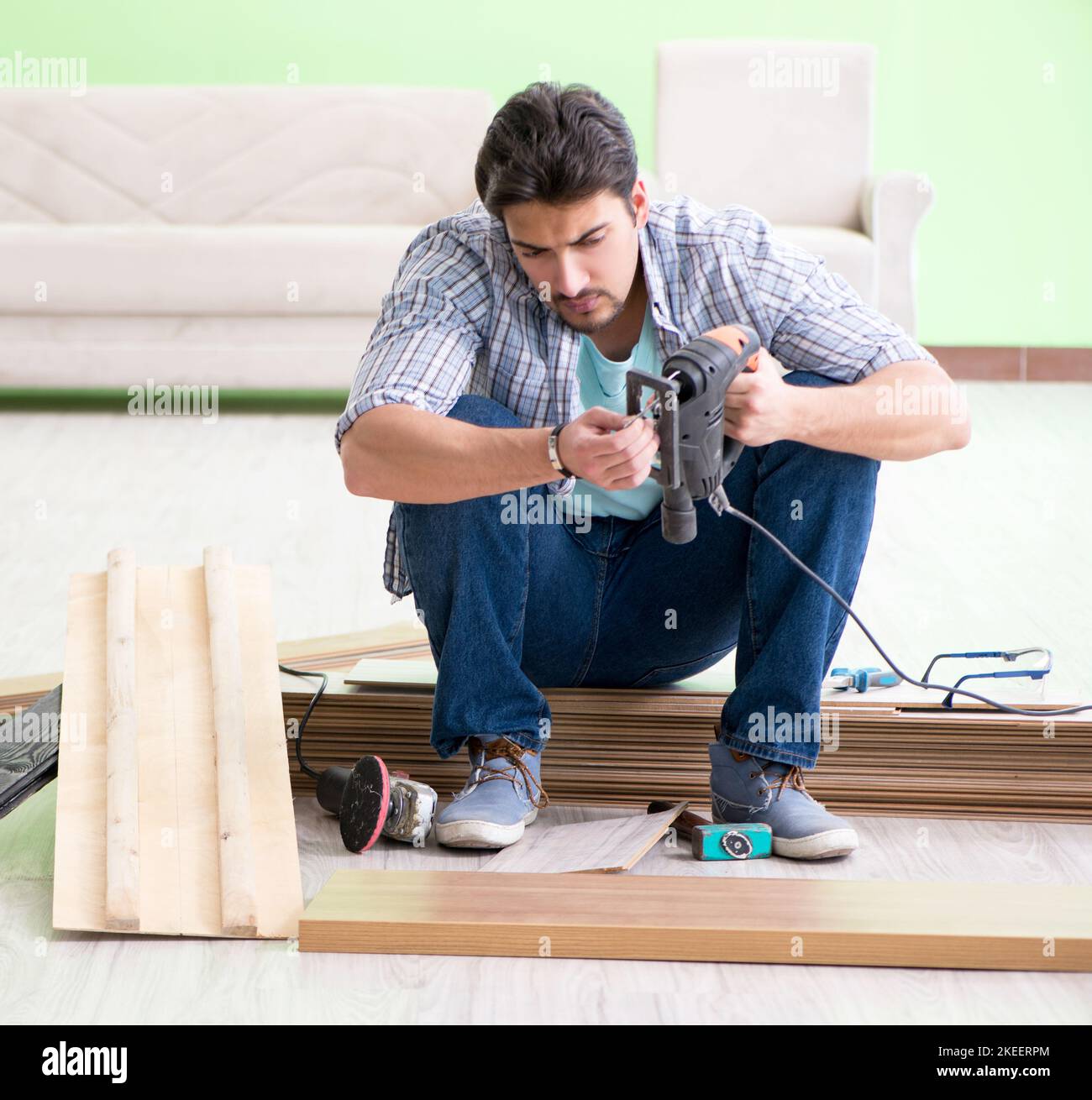 The man laying flooring at home Stock Photo - Alamy
