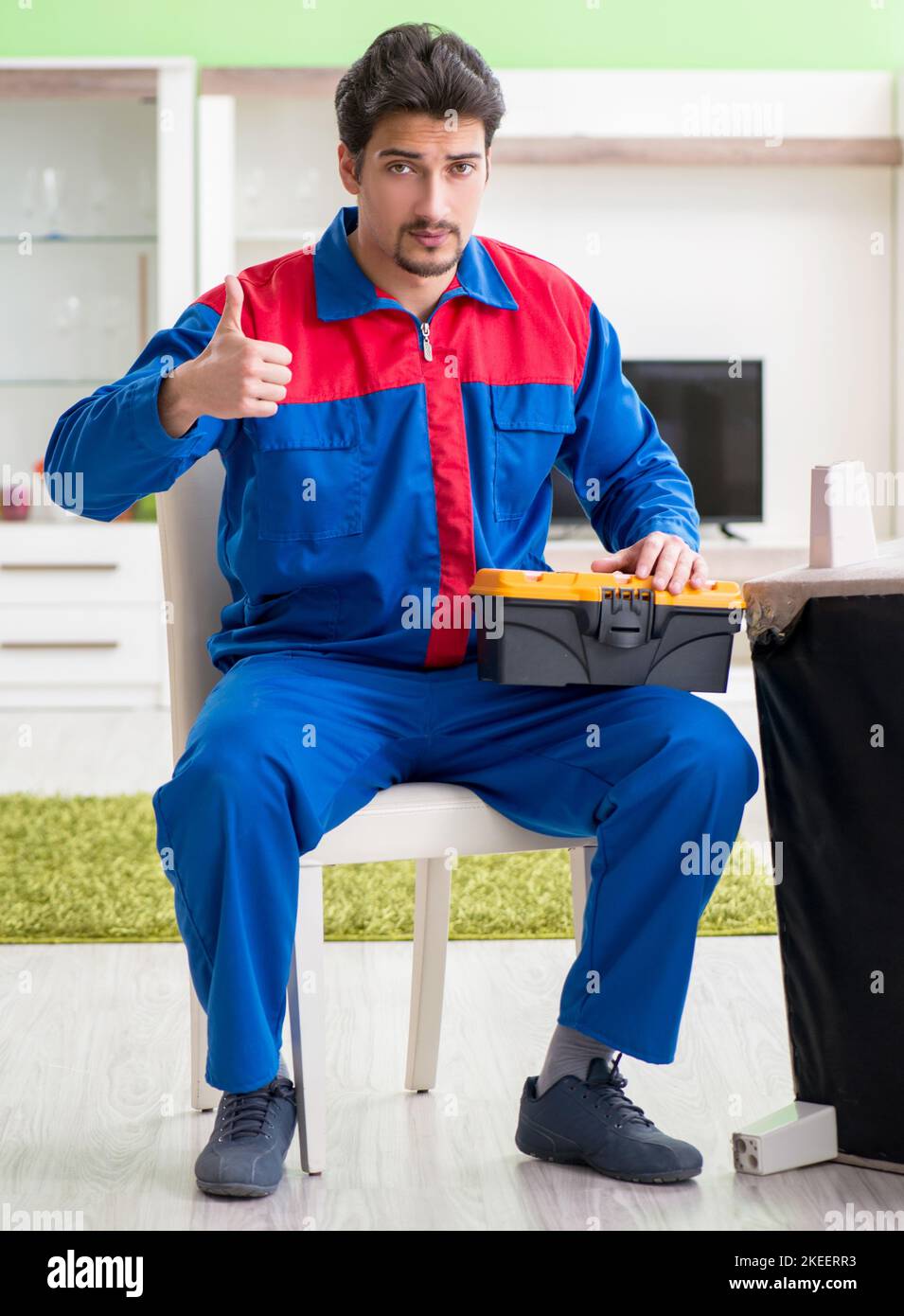 The repair contractor repairing broken furniture at home Stock Photo ...