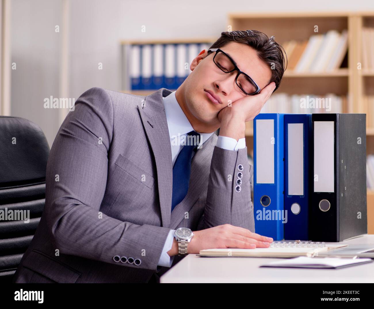 The sleepy businessman working in office Stock Photo - Alamy