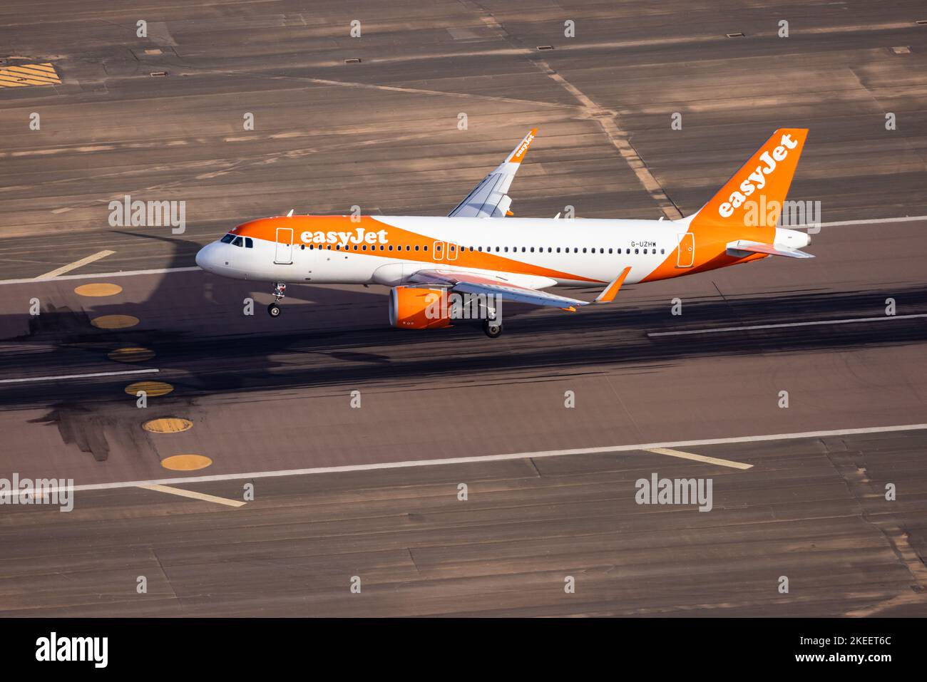 EasyJet Airplane landing to the airport during sunny morning. Aerial ...