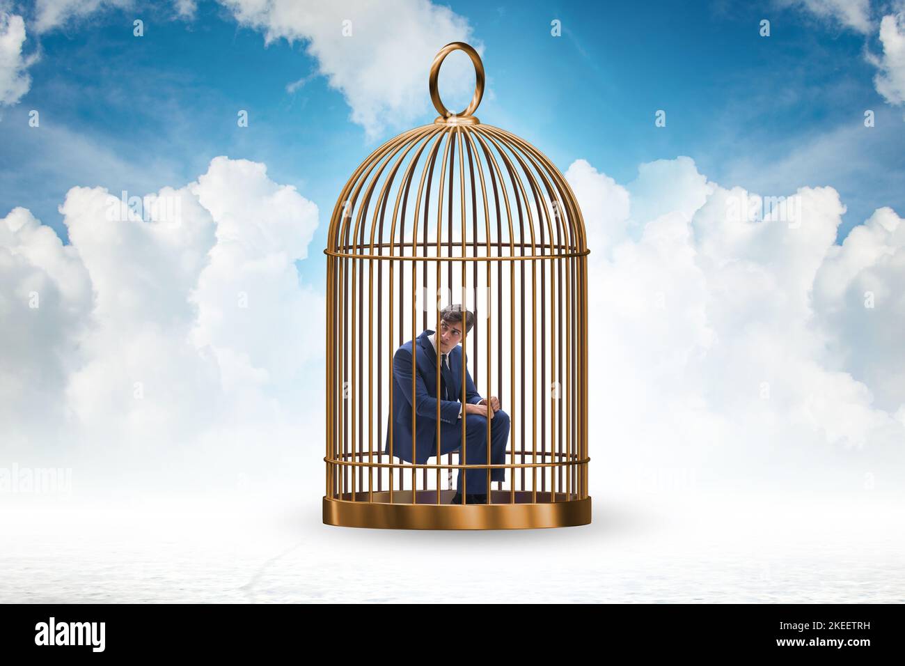 Business people and the golden cage concept Stock Photo - Alamy