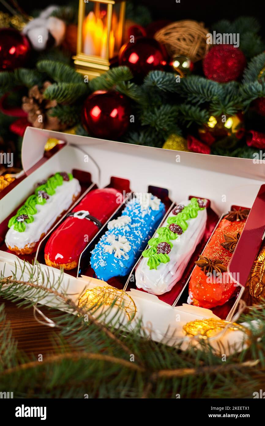 Christmas eclairs with cherry and cream fillings on a background of ...