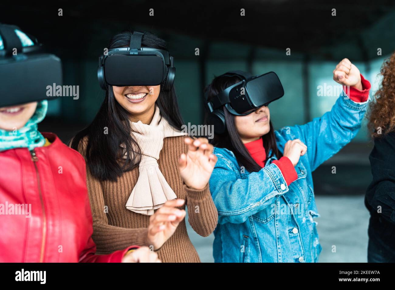 Young multiracial girls using futuristic virtual reality glasses ...