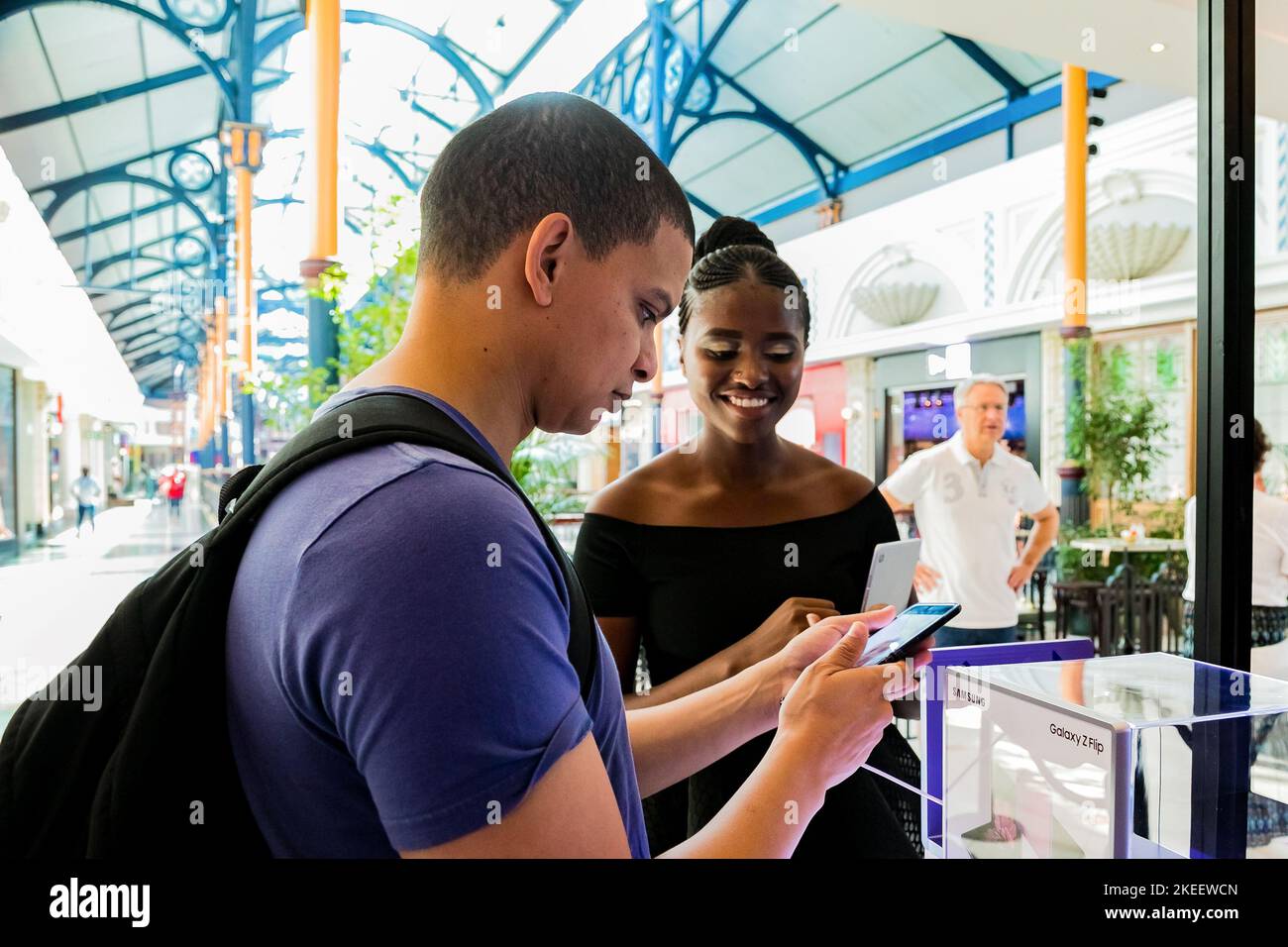 A customer checking the camera of a Samsung phone at a mall pop-up ...