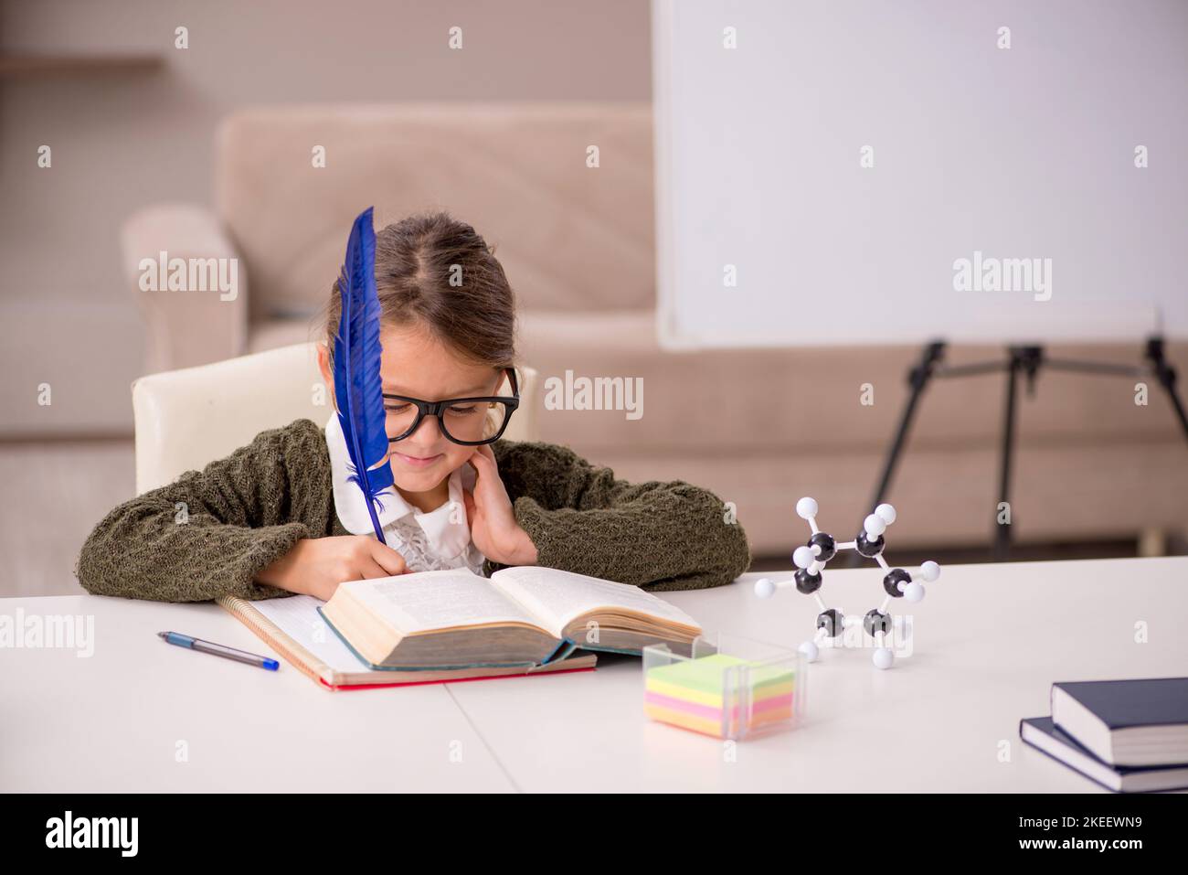 Young small girl studying at home Stock Photo - Alamy