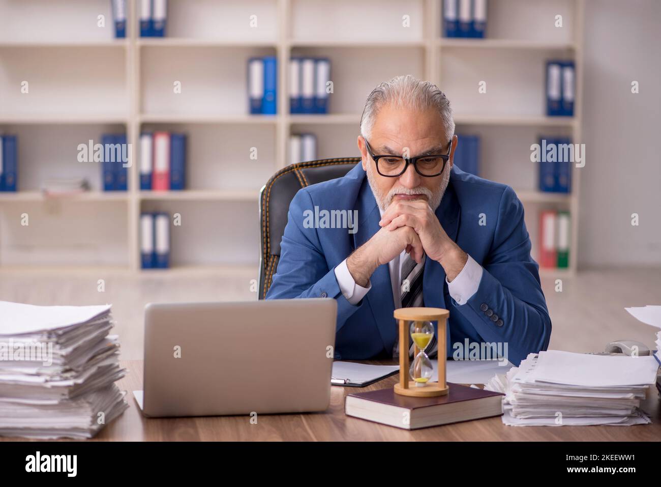 Old businessman employee in time management concept Stock Photo - Alamy