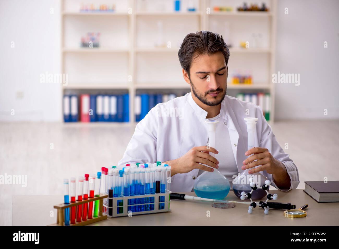 Young chemist working at the lab Stock Photo - Alamy