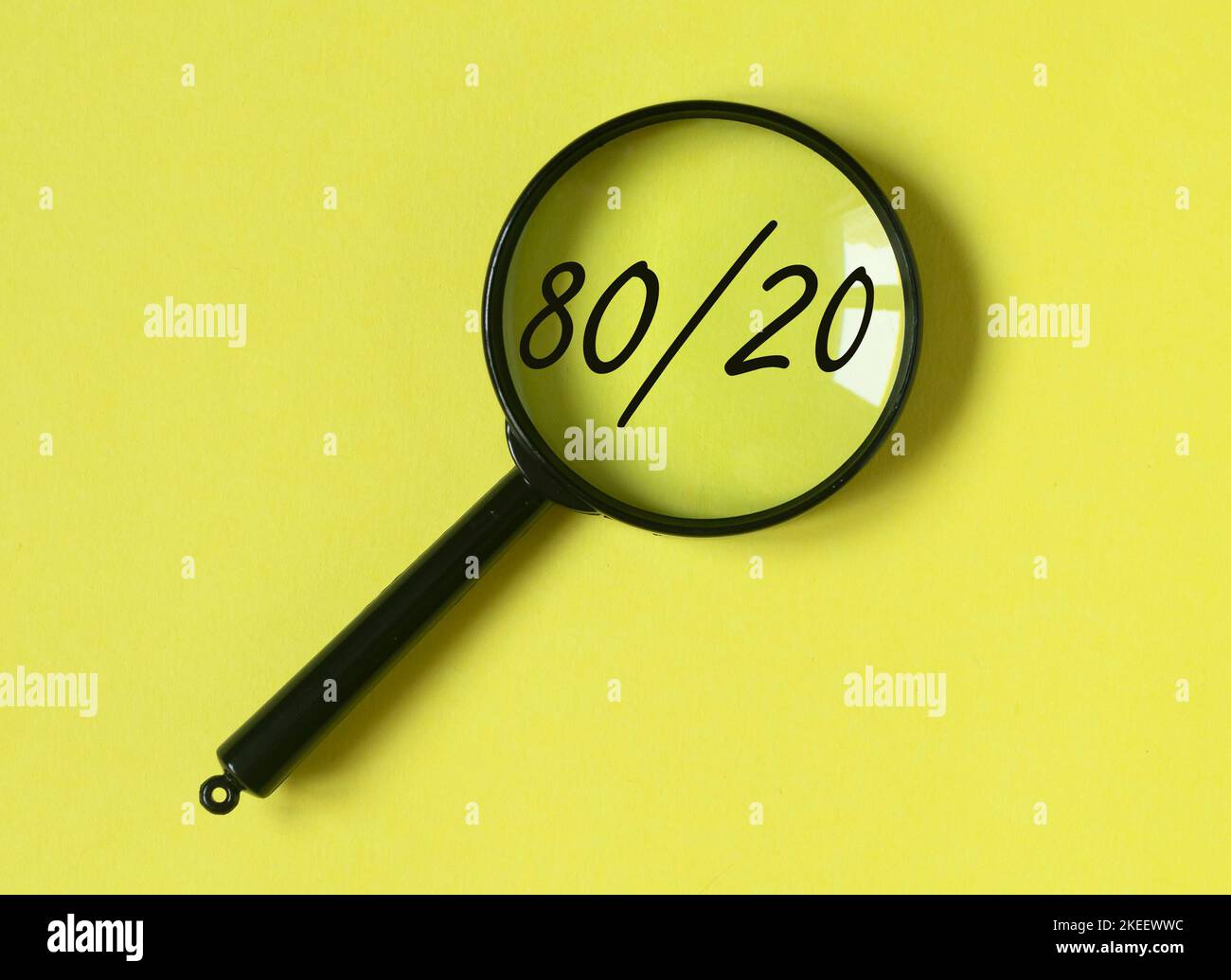 80 20 pareto principle concept, text through magnifying glass on yellow ...