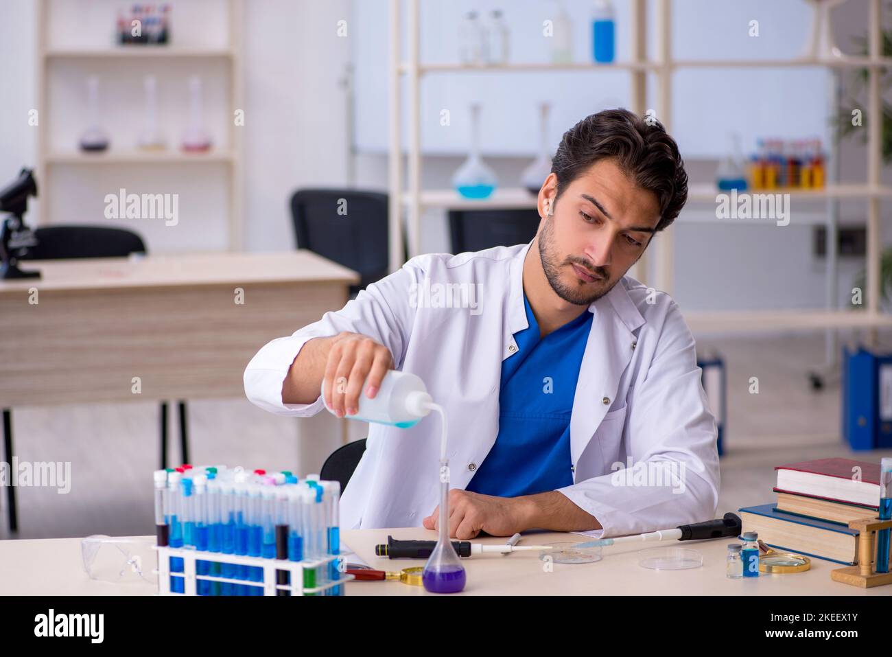 Young chemist working at the lab Stock Photo - Alamy
