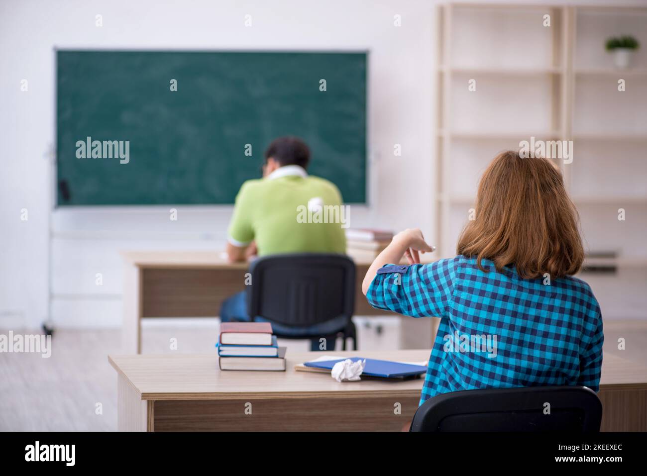 Two students having fun during the lesson Stock Photo - Alamy