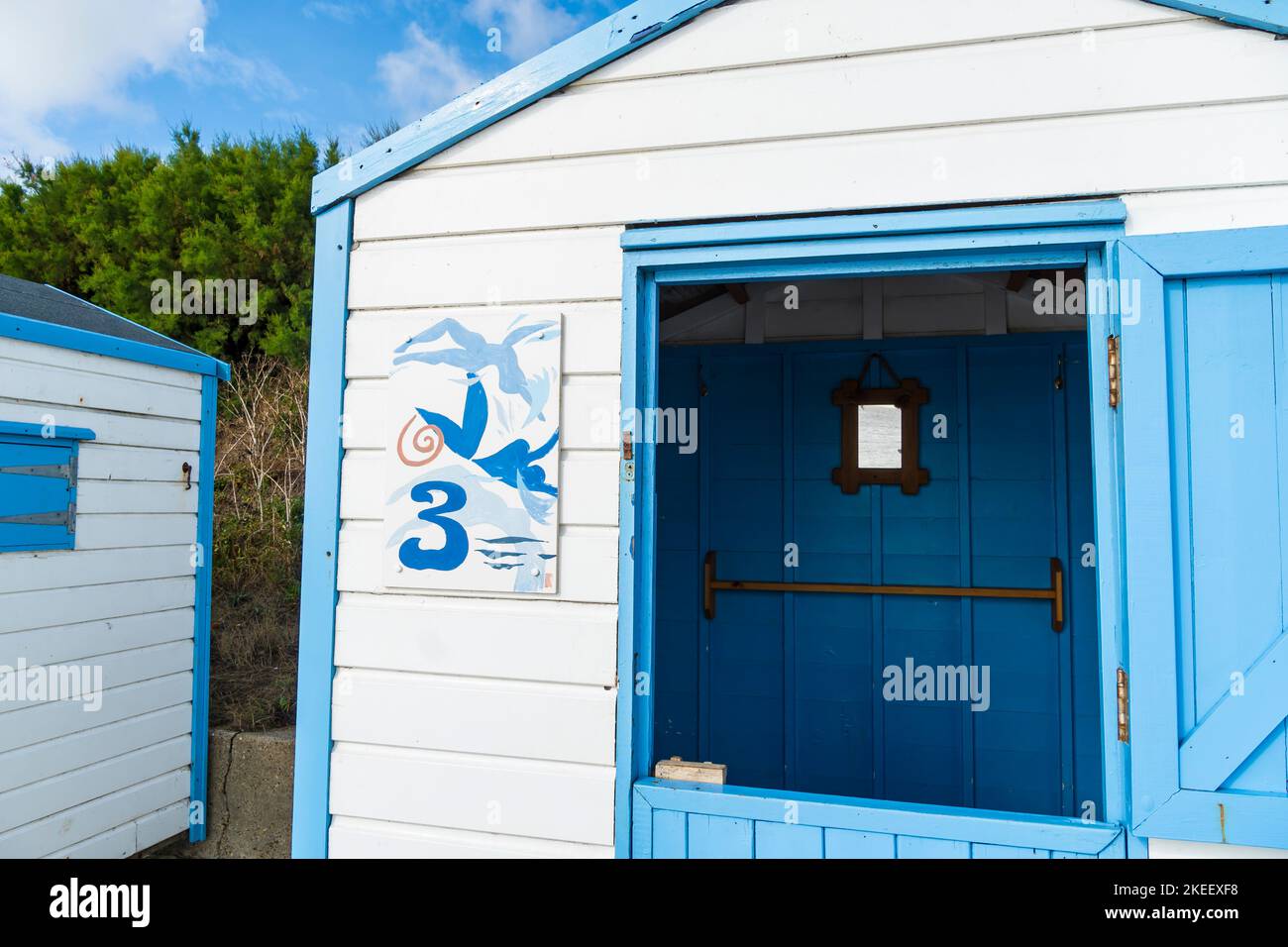 Blue and white beach hut with painted number sign on wall Southwold ...