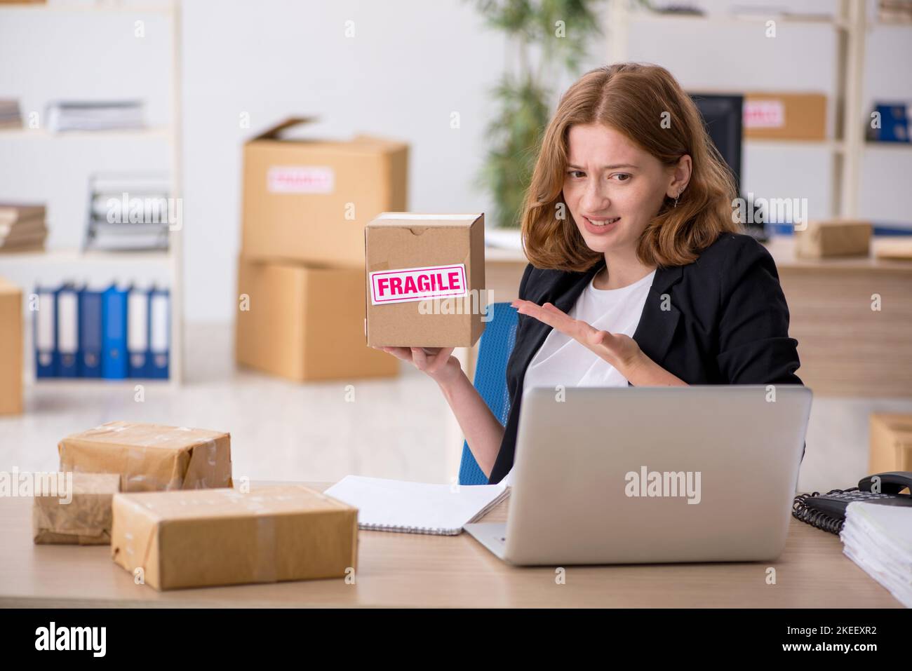 Young businesswoman working in box delivery service Stock Photo - Alamy
