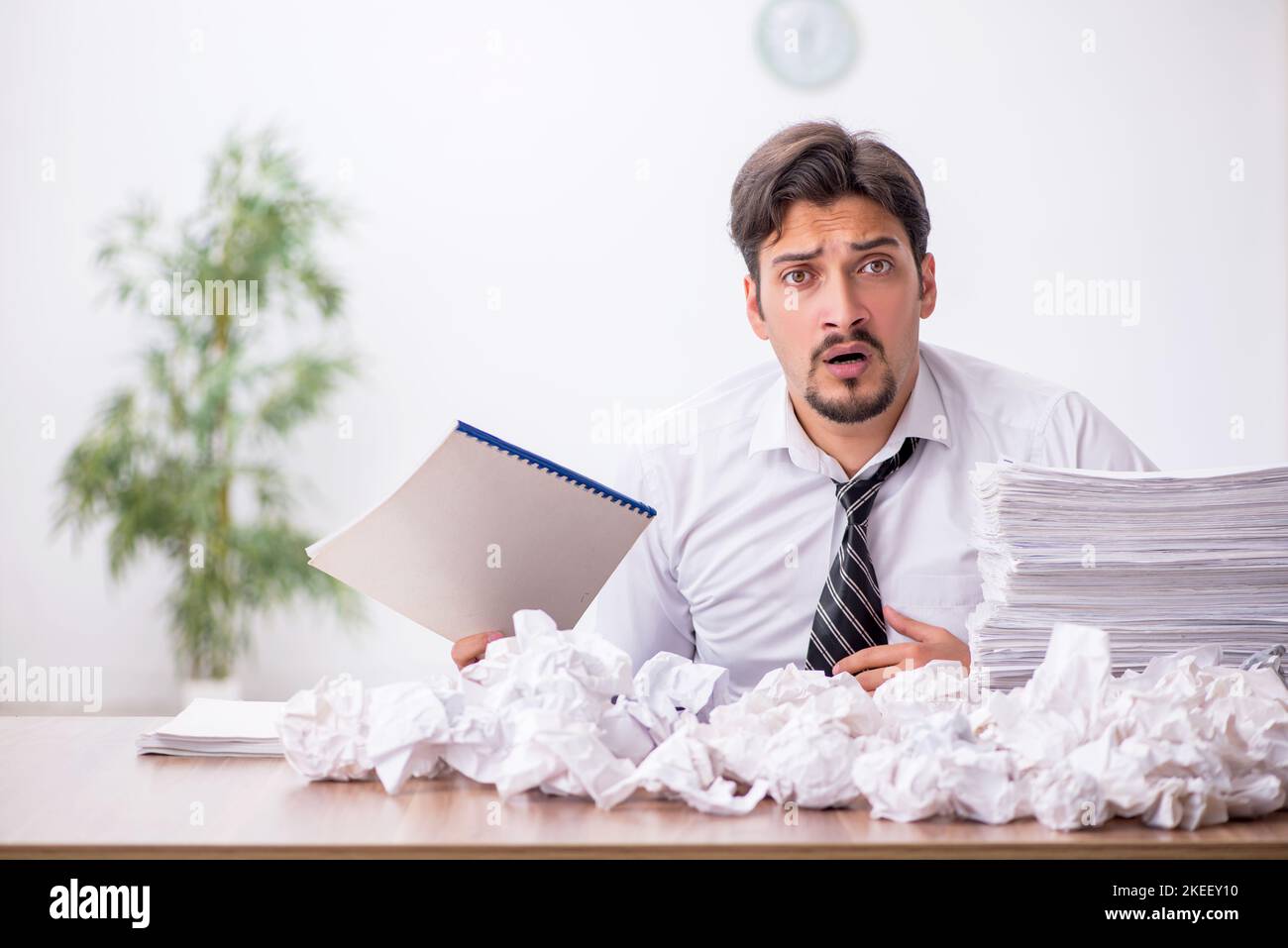 Young businessman employee in brainstorming concept Stock Photo - Alamy