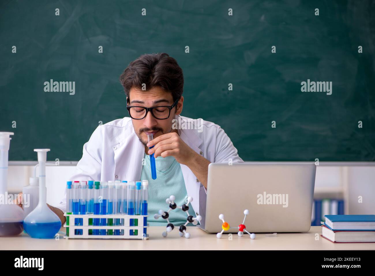 Young chemist in front of blackboard Stock Photo - Alamy