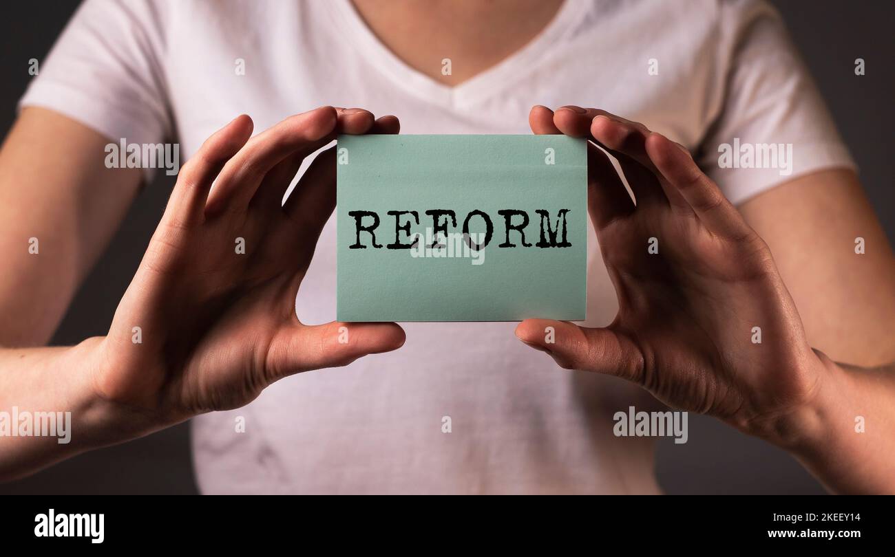 Word Reform on paper in female hands. Reforming Stock Photo - Alamy