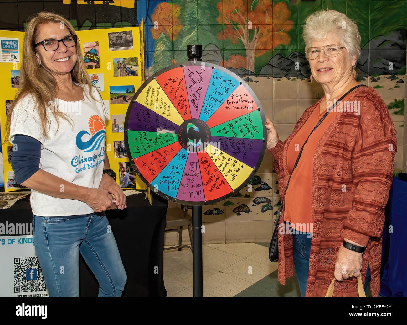 Woman playing a colorful game of chance wheel with inspirational ideas ...