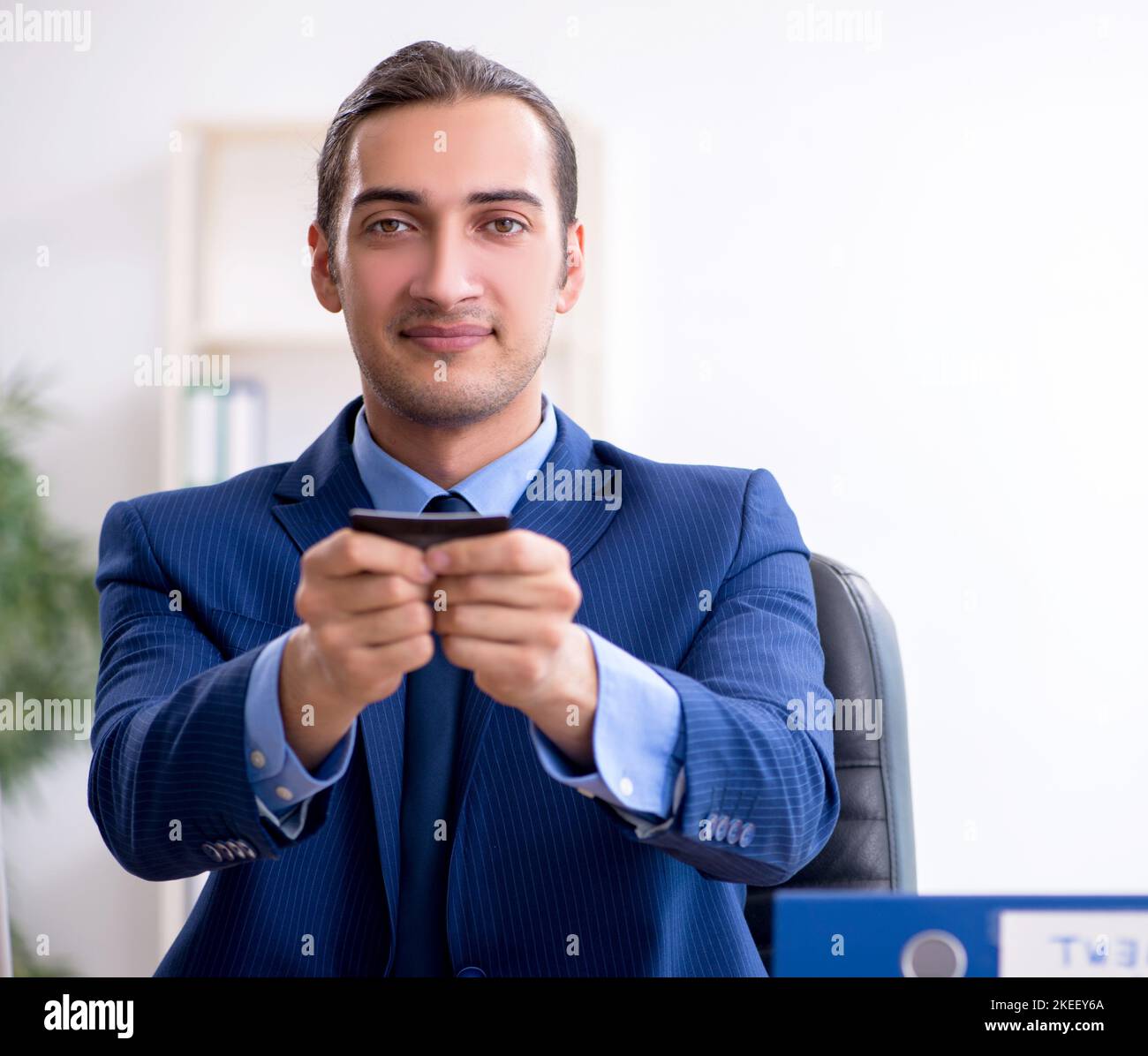 The young male accountant working in the office Stock Photo - Alamy