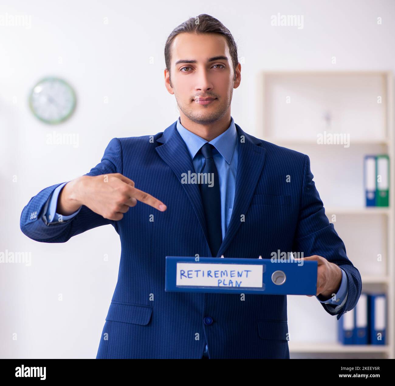 The young male accountant working in the office Stock Photo - Alamy