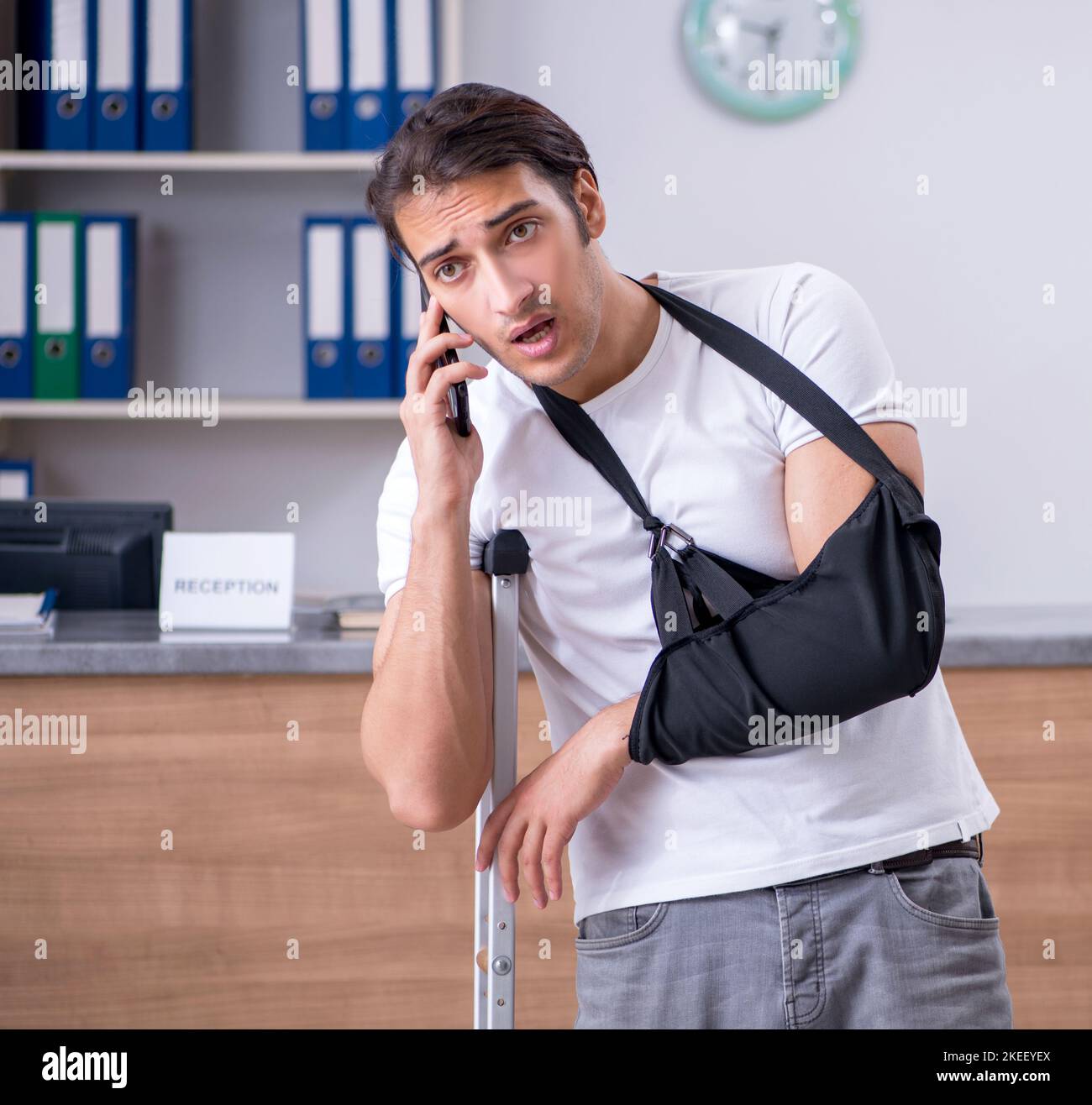 Clinic reception counter and young patient Stock Photo - Alamy