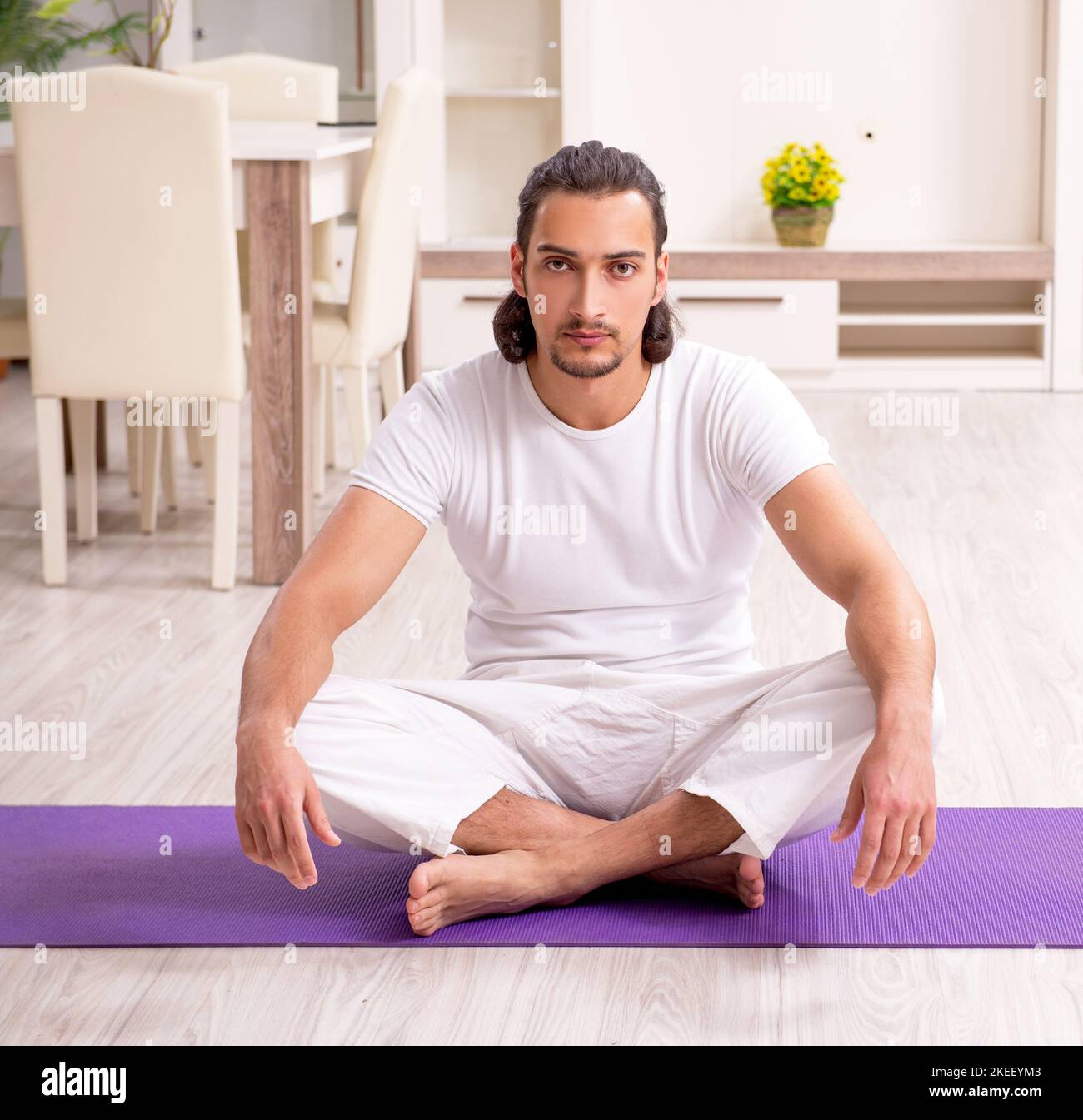 The young man doing physical exercises at home Stock Photo - Alamy