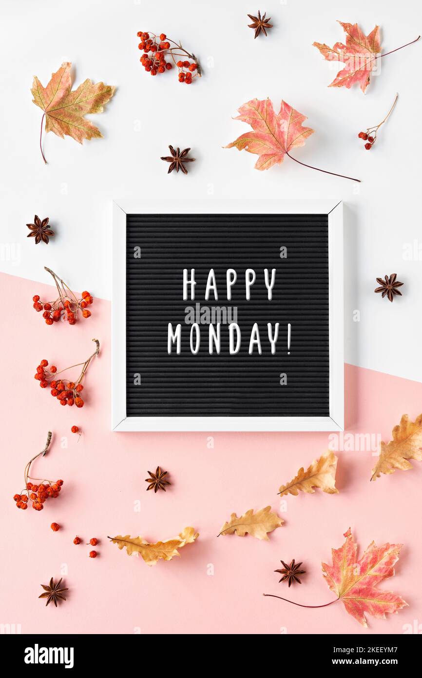 Happy Monday greeting text on text board. Autumn leaves, spices and ...