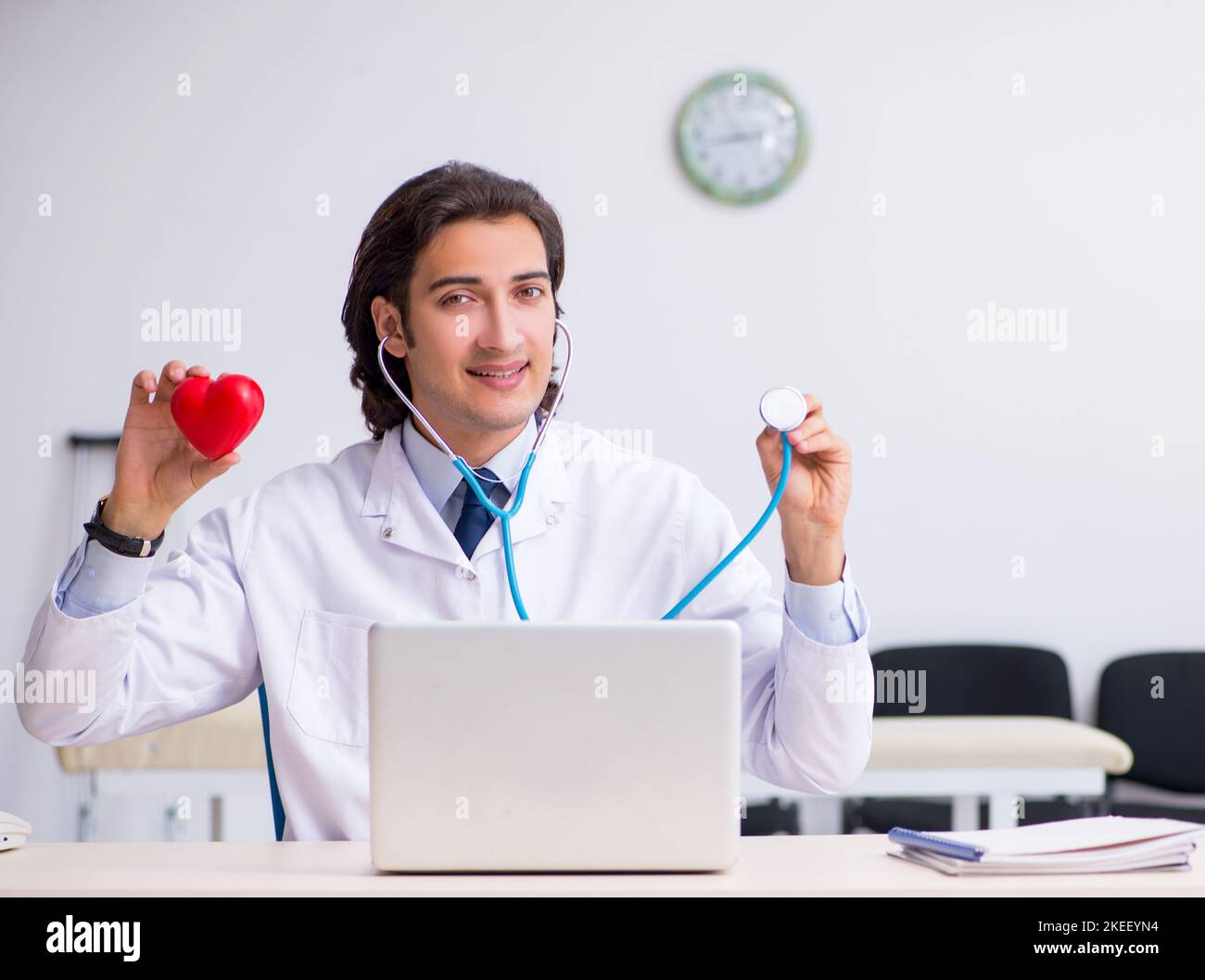 The young handsome doctor cardiologist working in the clinic Stock ...