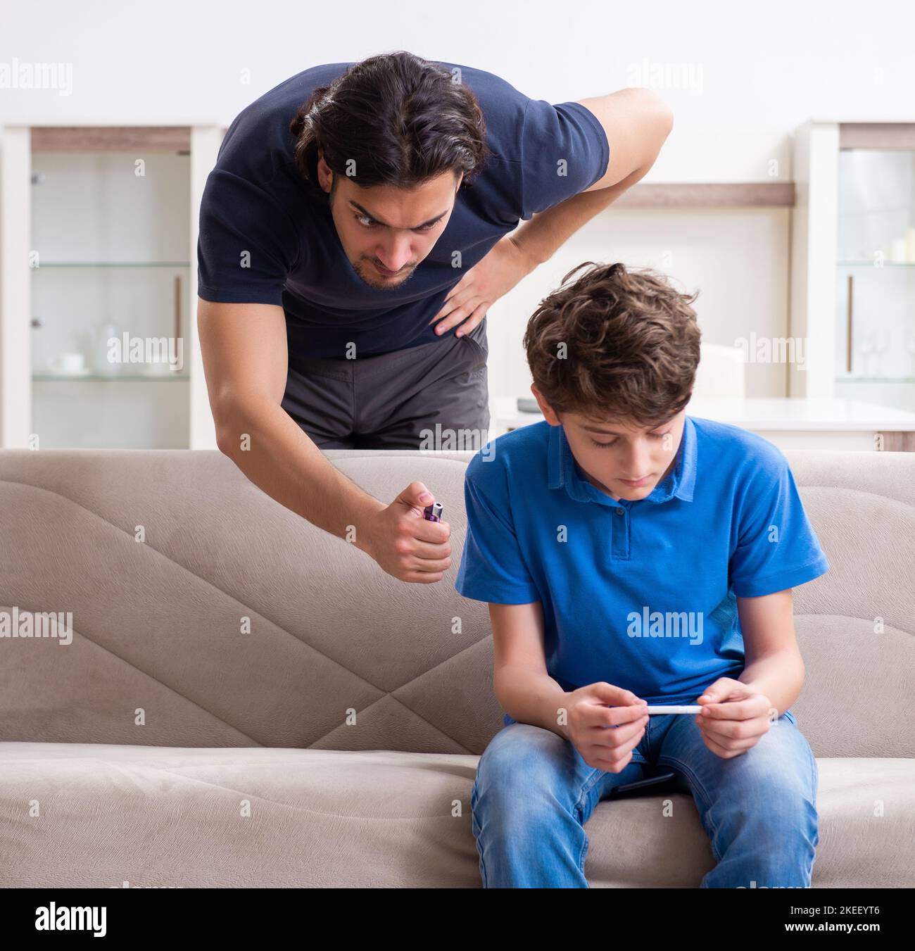 The concept of underage smoking with young boy and family Stock Photo ...