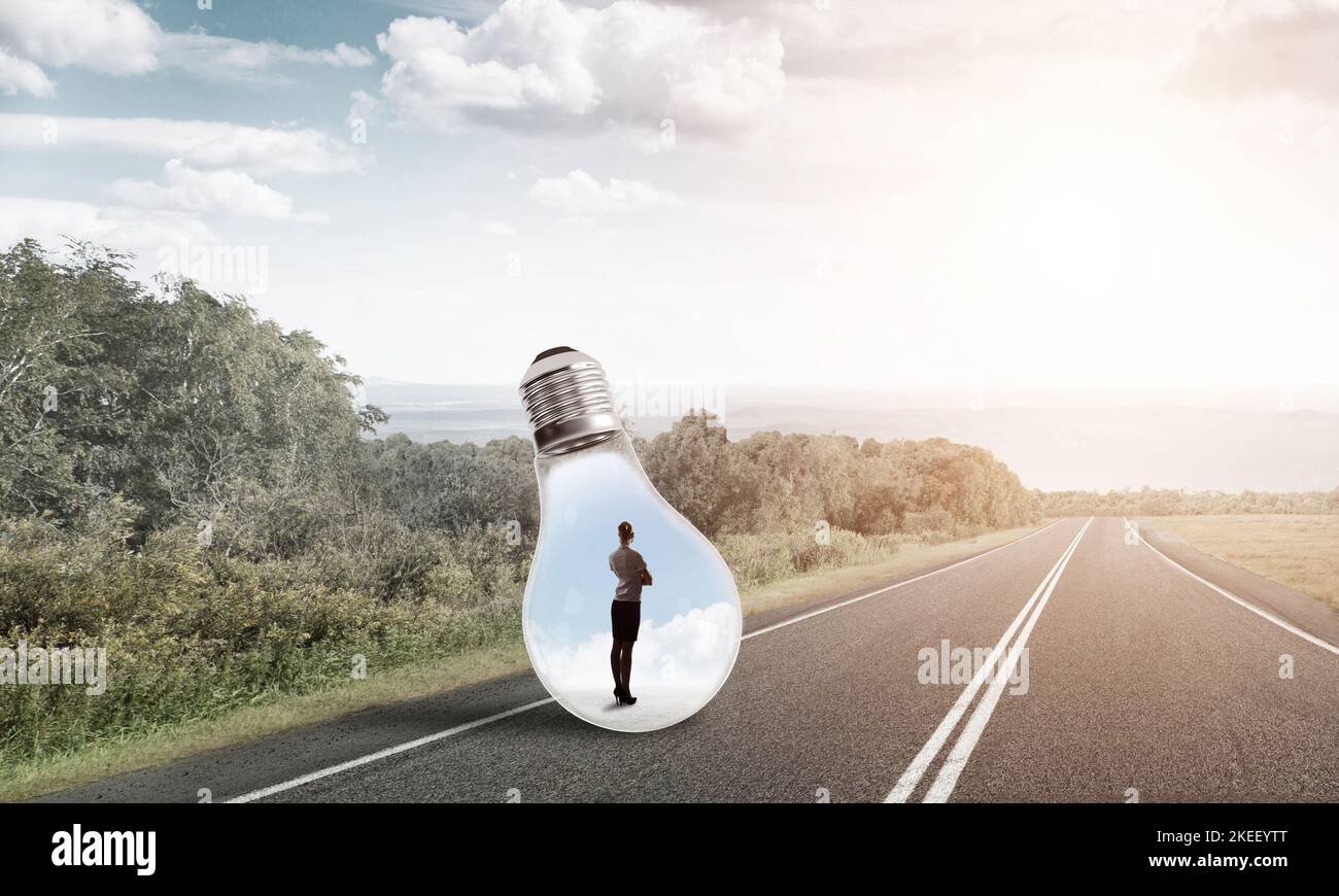 Businesswoman inside light bulb Stock Photo - Alamy