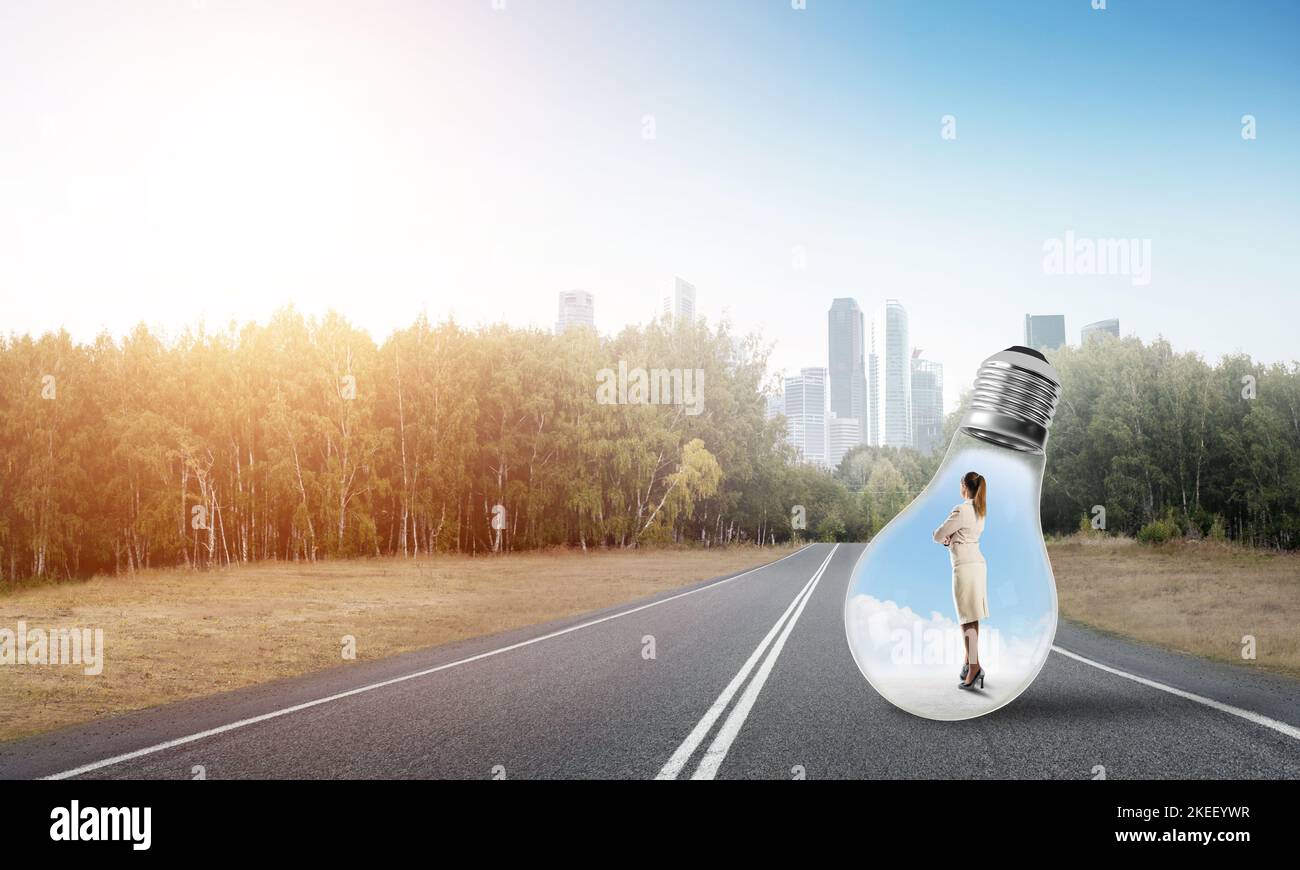 Businesswoman inside light bulb Stock Photo - Alamy