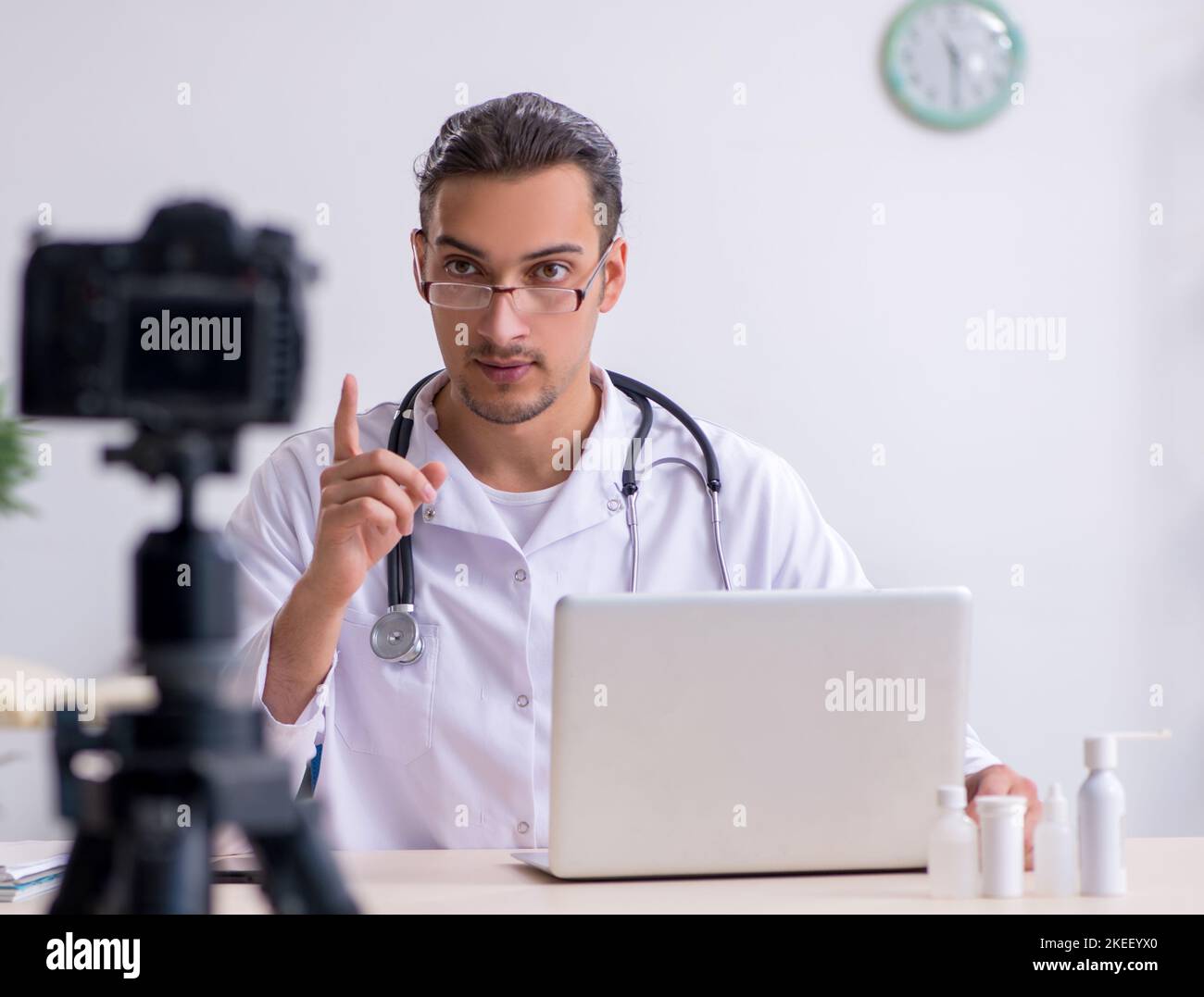 The young male doctor recording video for his blog Stock Photo - Alamy