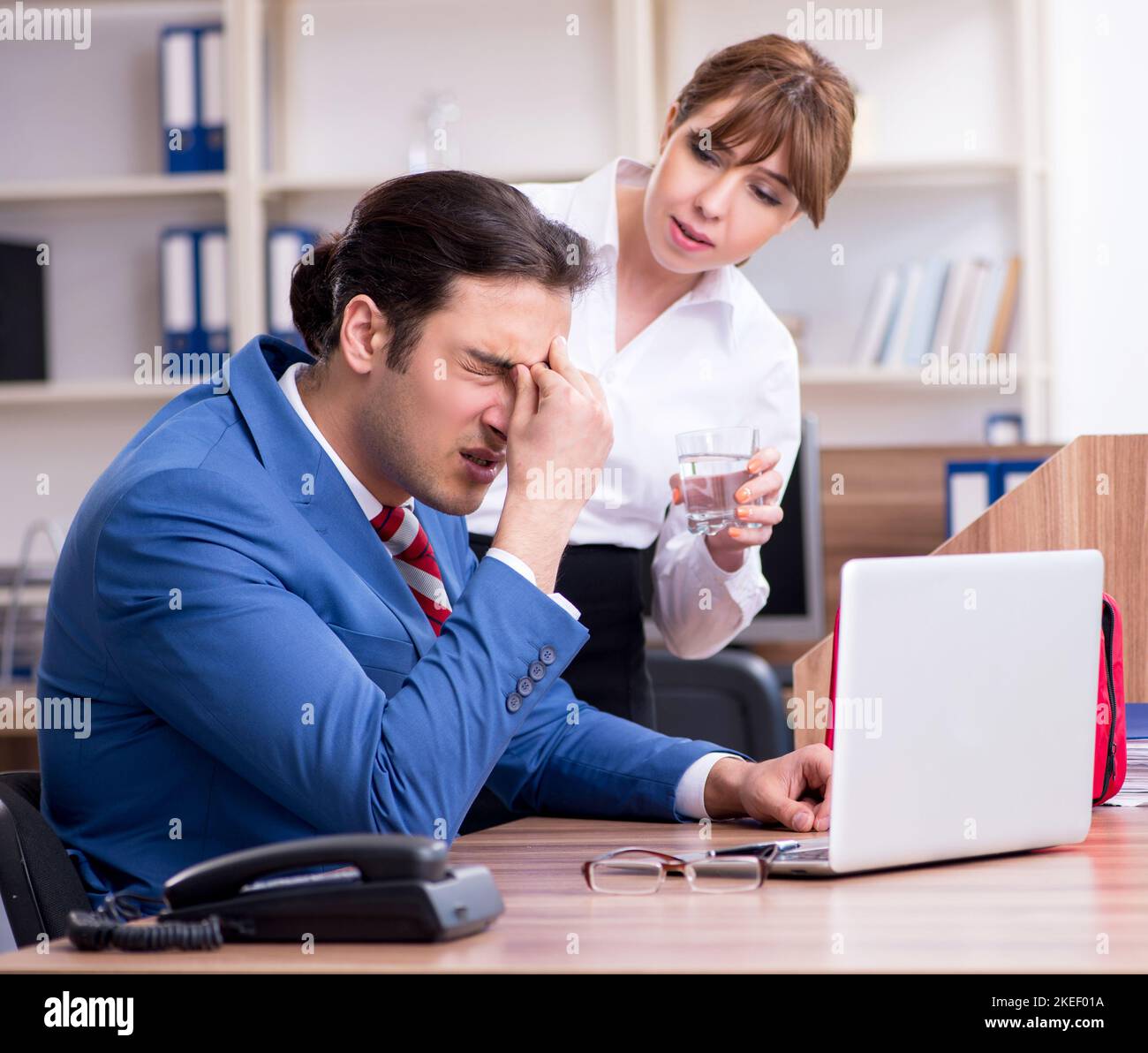 Employee receiving first aid in office Stock Photo - Alamy