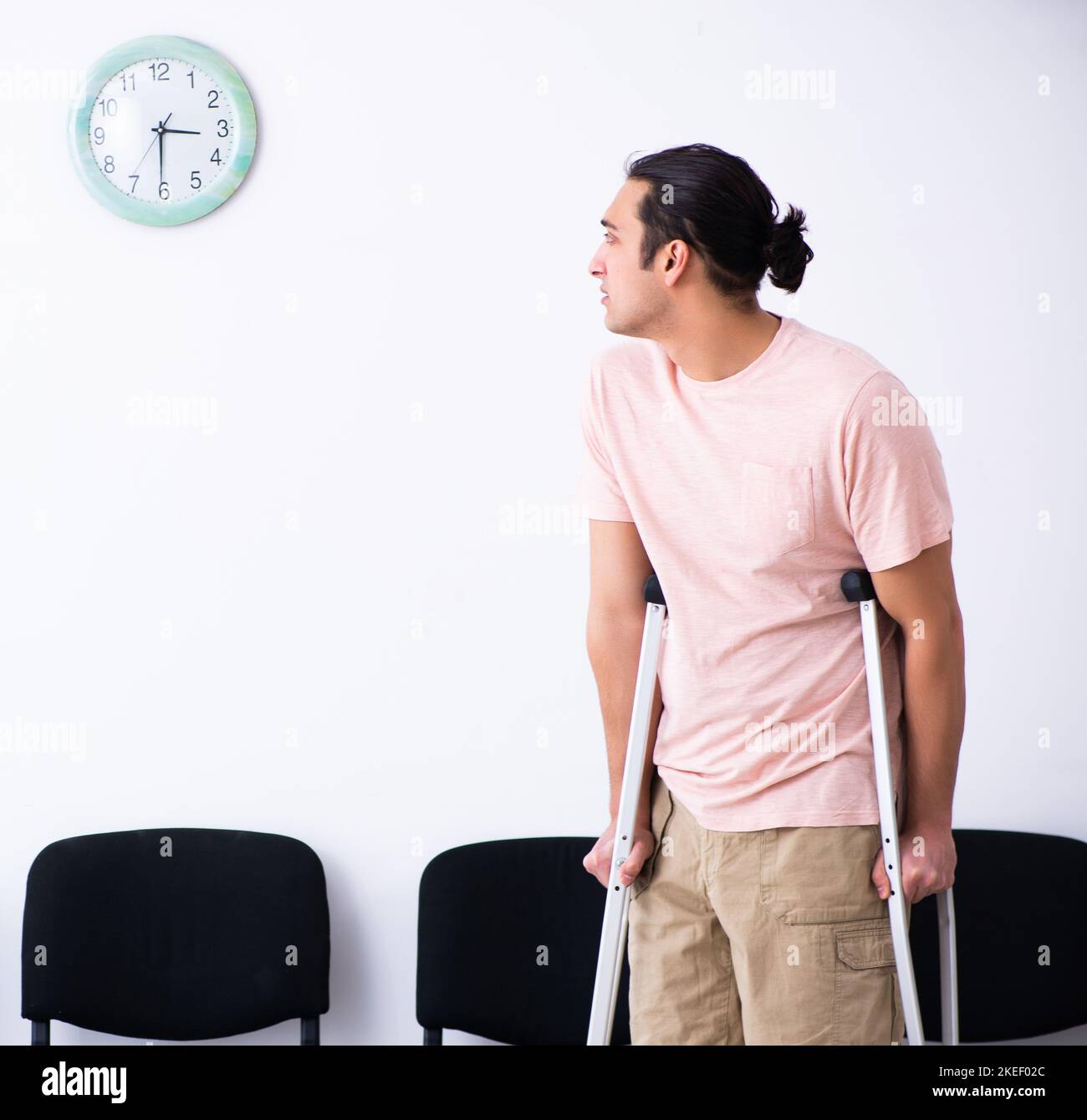 The young injured man waiting for his turn in hospital hall Stock Photo ...