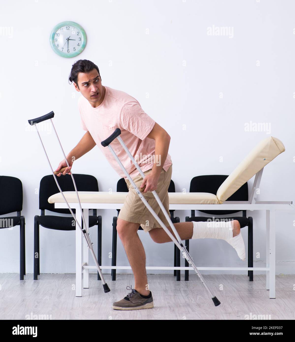 The young injured man waiting for his turn in hospital hall Stock Photo ...