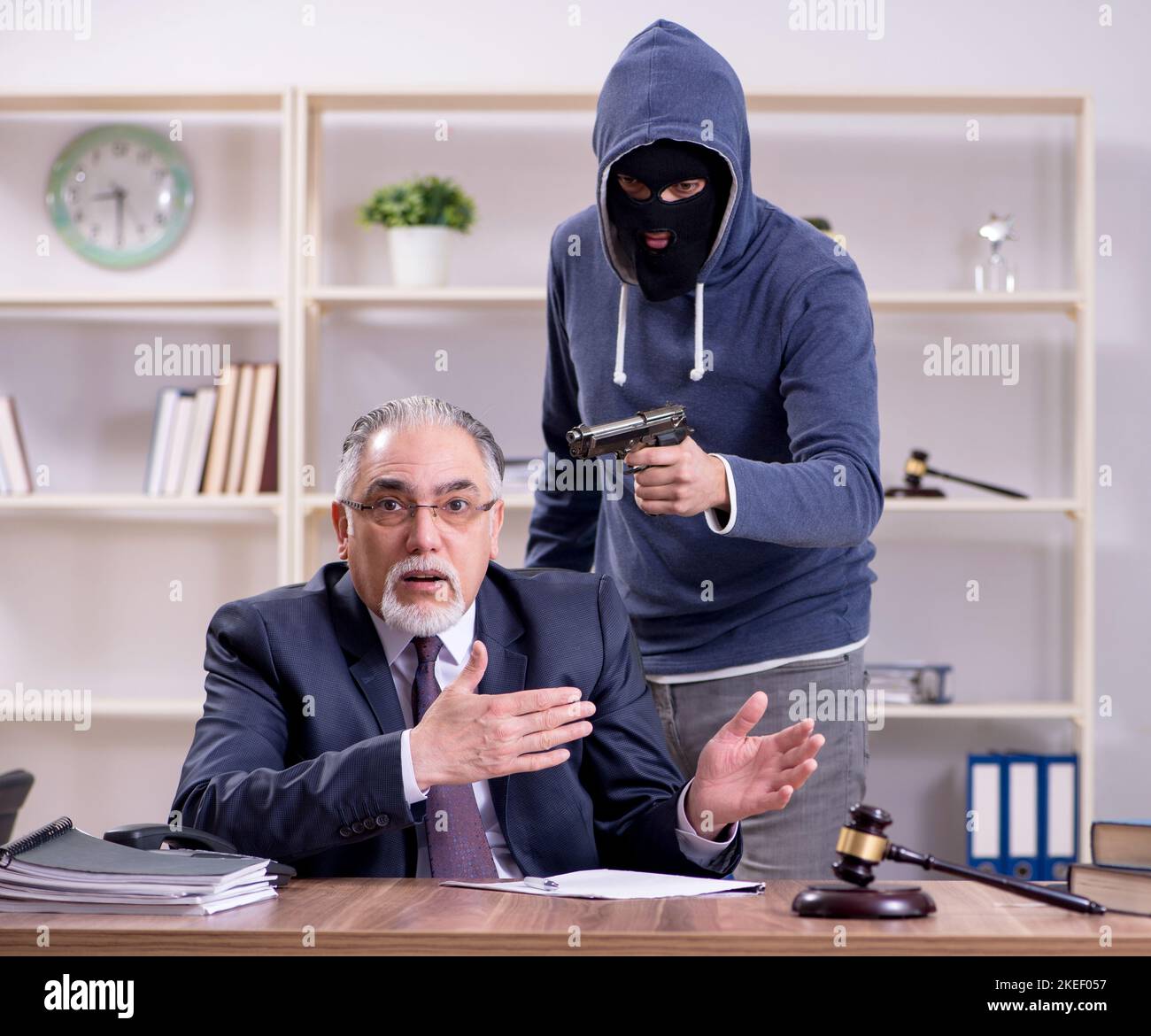 The young mobster threatening old judge Stock Photo - Alamy