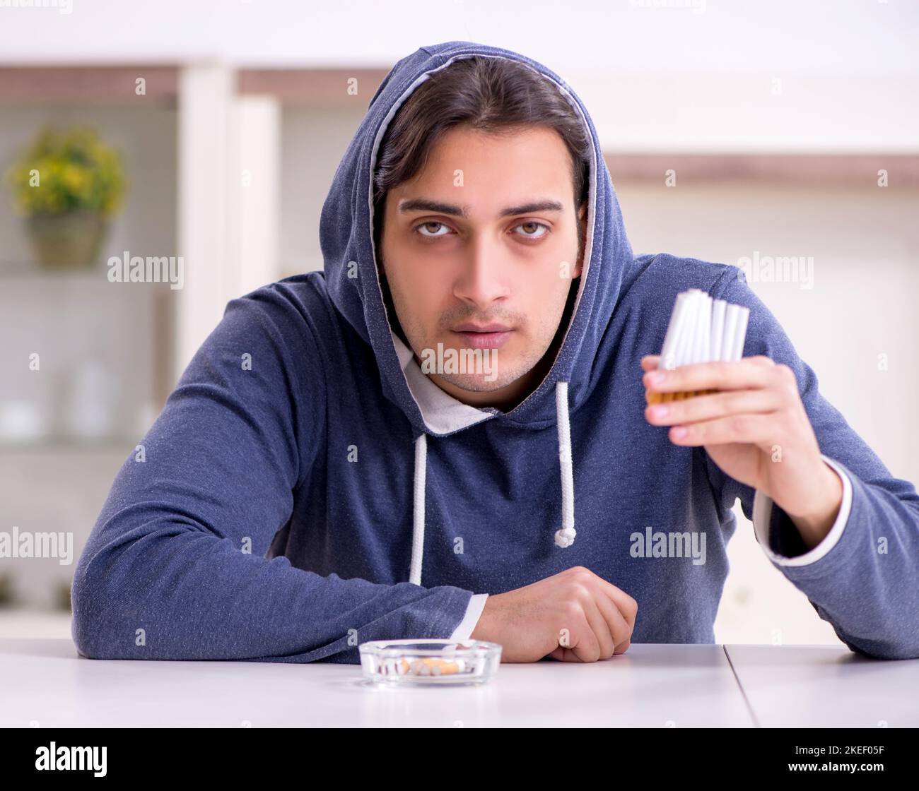 The young man having problems with narcotics at home Stock Photo - Alamy