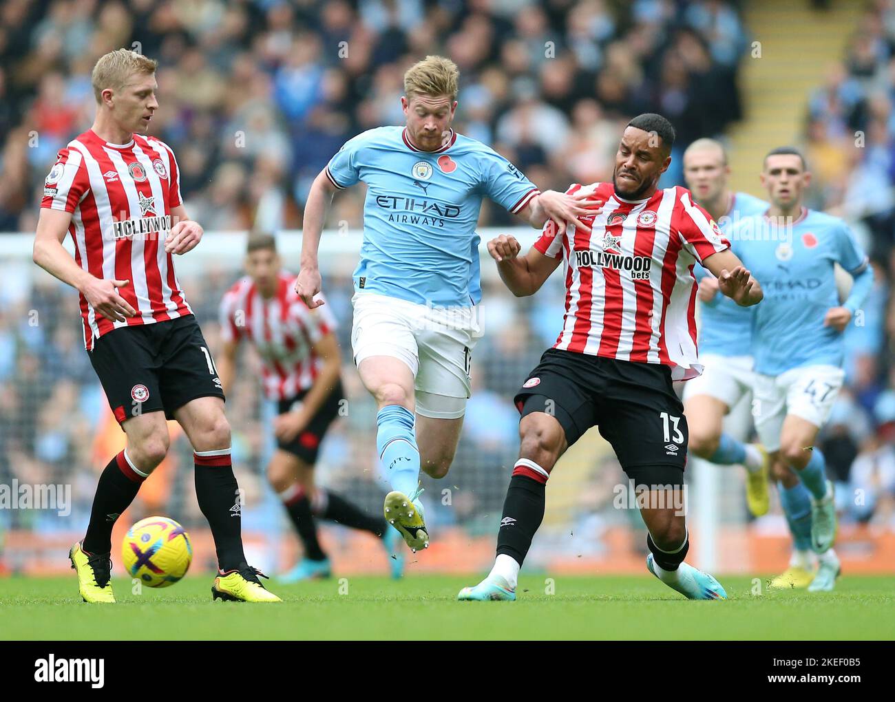 Manchester City's Kevin De Bruyne is challenged by Brentford's Mathias ...