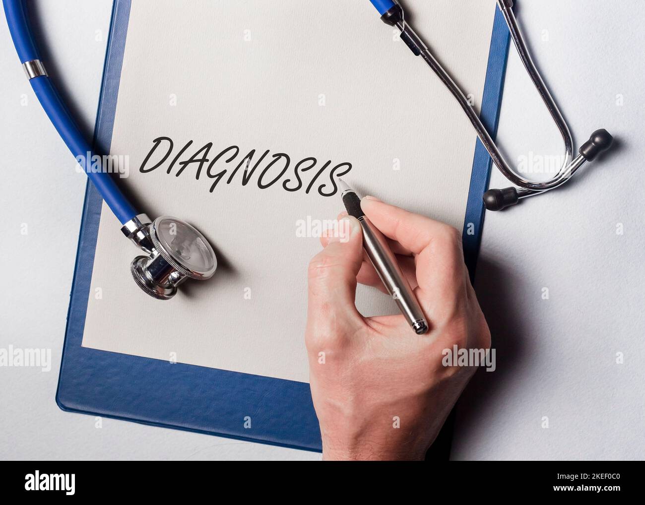 Diagnosis word, doctor writing text with pen Stock Photo - Alamy