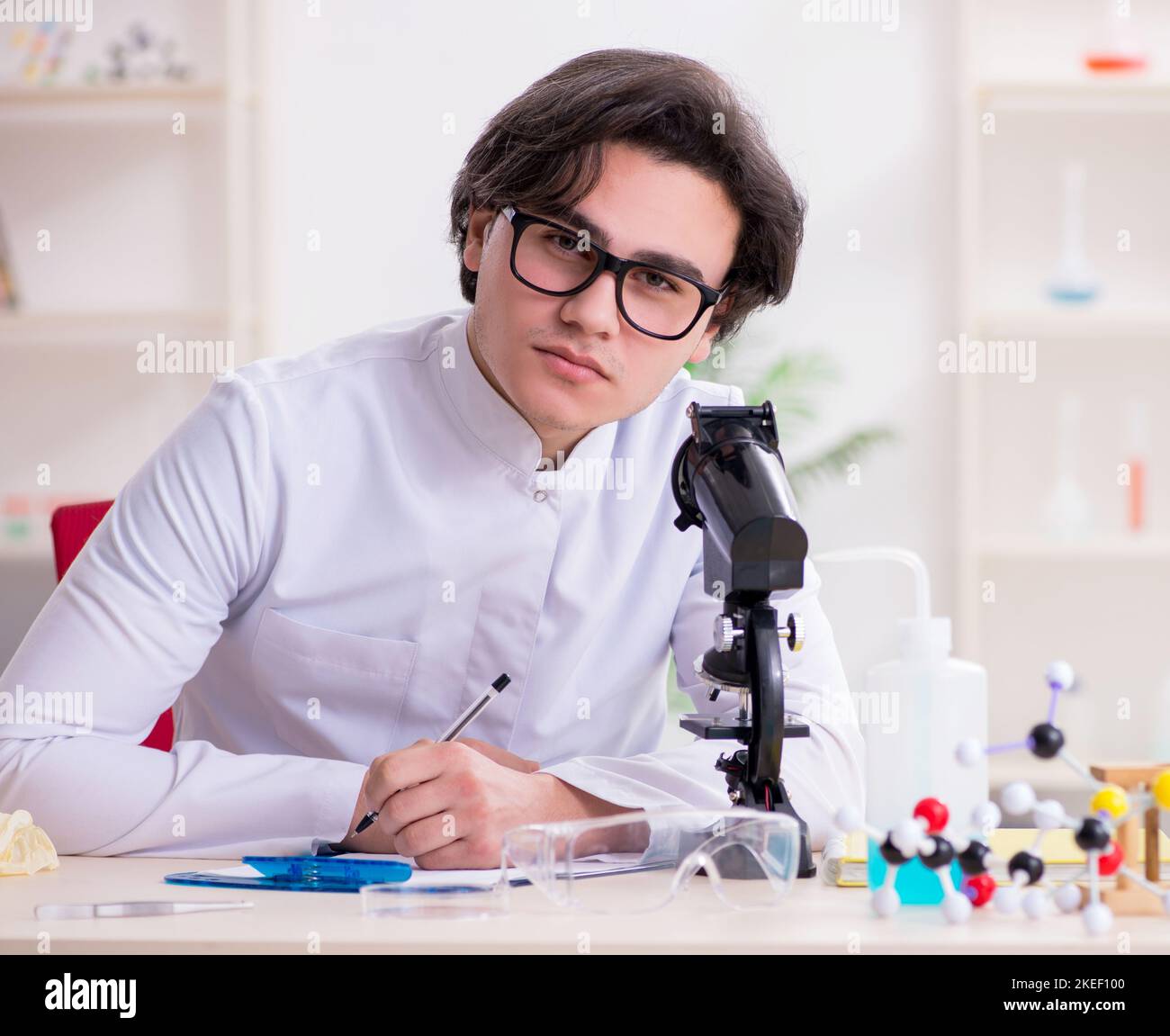 The young male biochemist working in the lab Stock Photo - Alamy