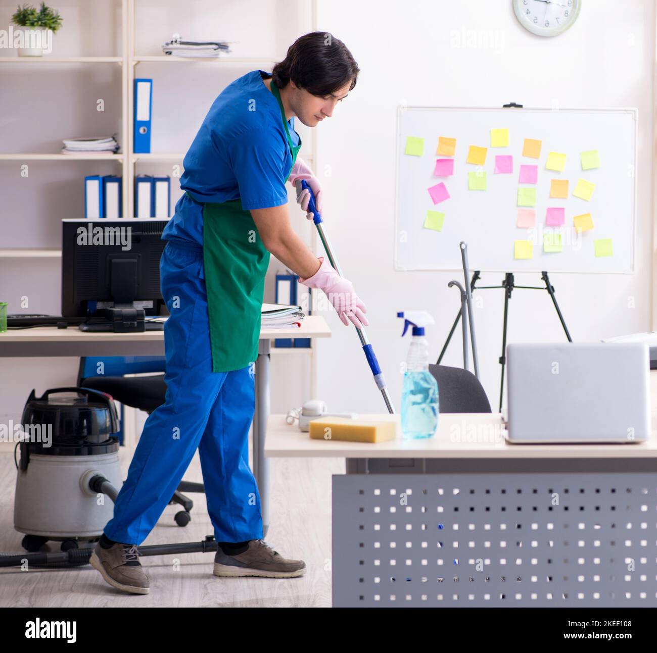 The male handsome professional cleaner working in the office Stock ...