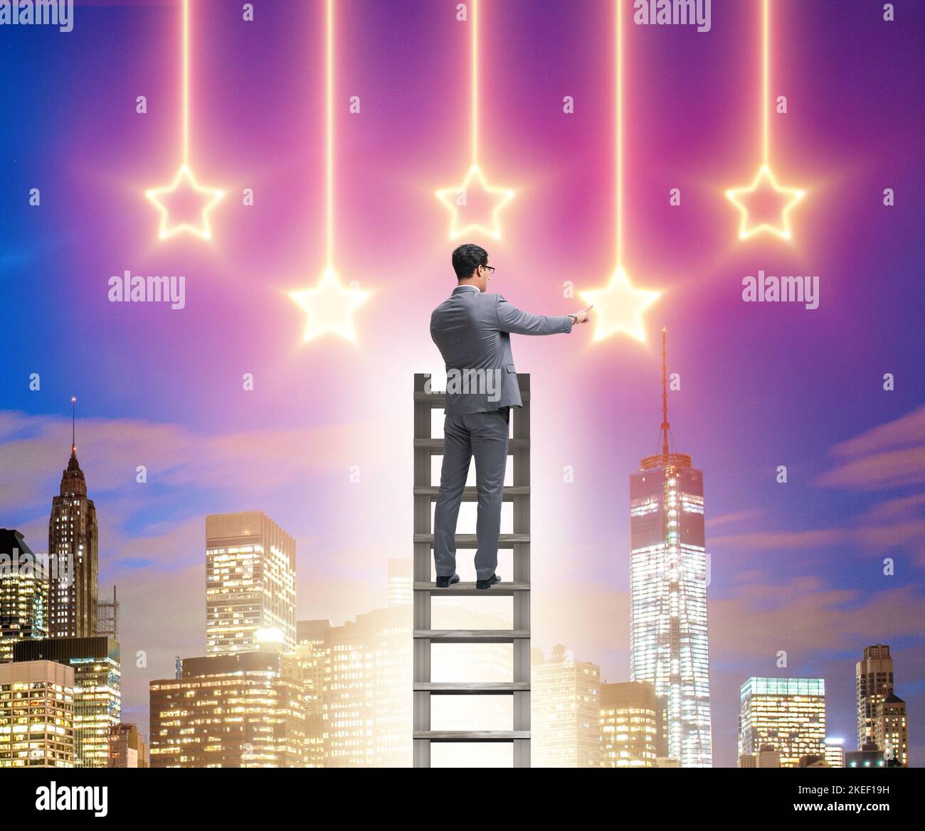 The businessman reaching out for stars Stock Photo - Alamy