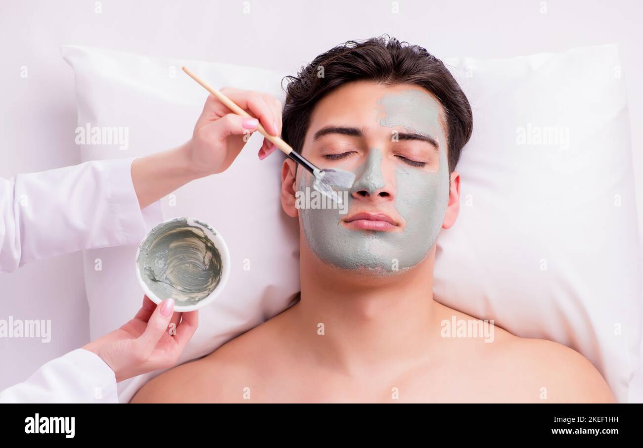 The handsome man in spa massage concept Stock Photo - Alamy