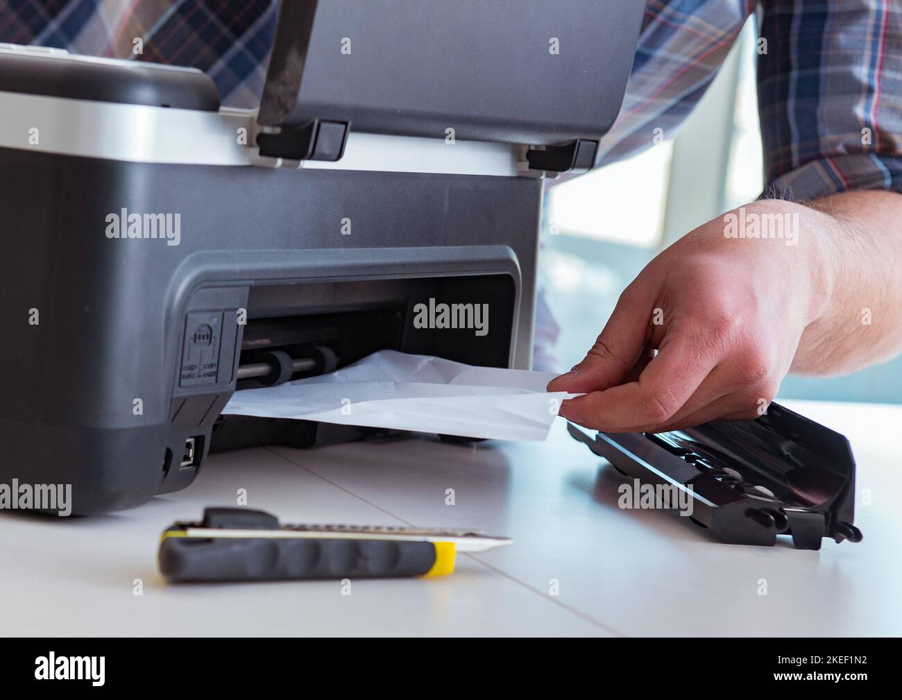 The repairman repairing broken color printer Stock Photo - Alamy