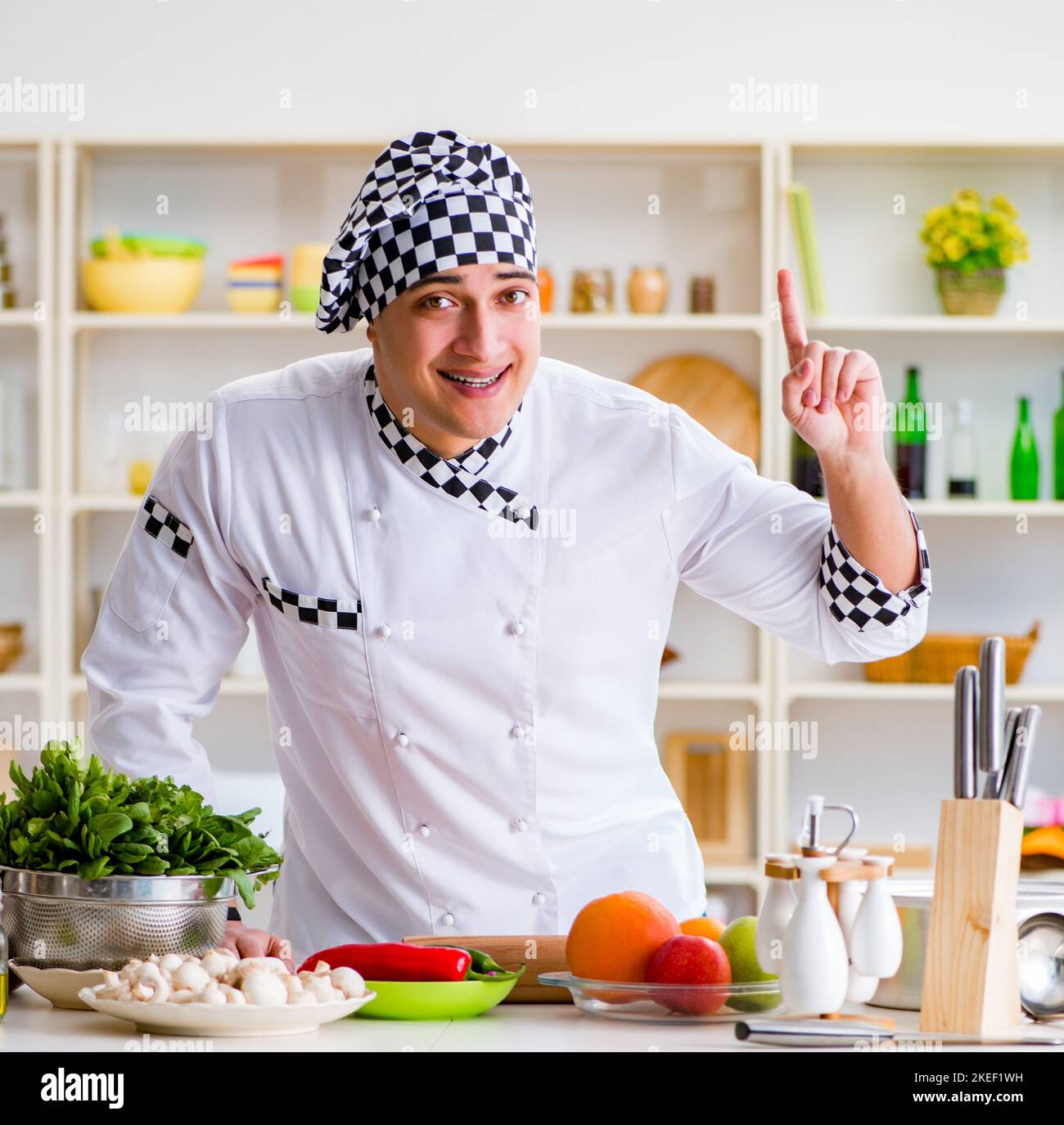 The young male cook working in the kitchen Stock Photo - Alamy