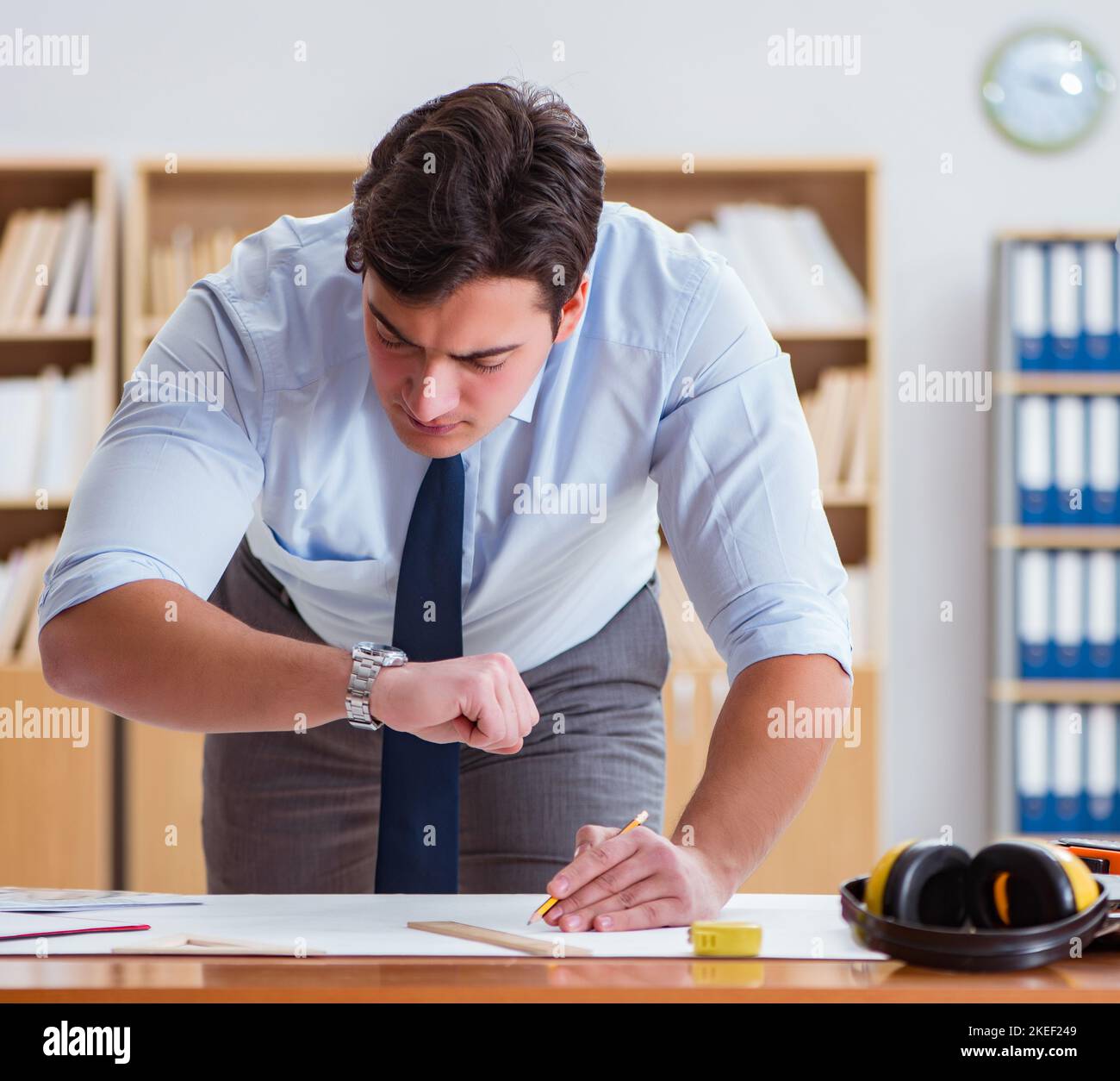 The engineer supervisor working on drawings in the office Stock Photo ...