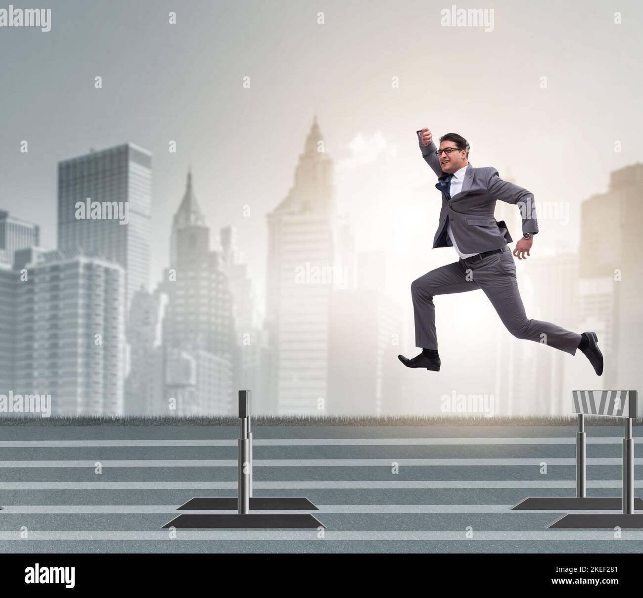 The businessman jumping over barriers in business concept Stock Photo ...