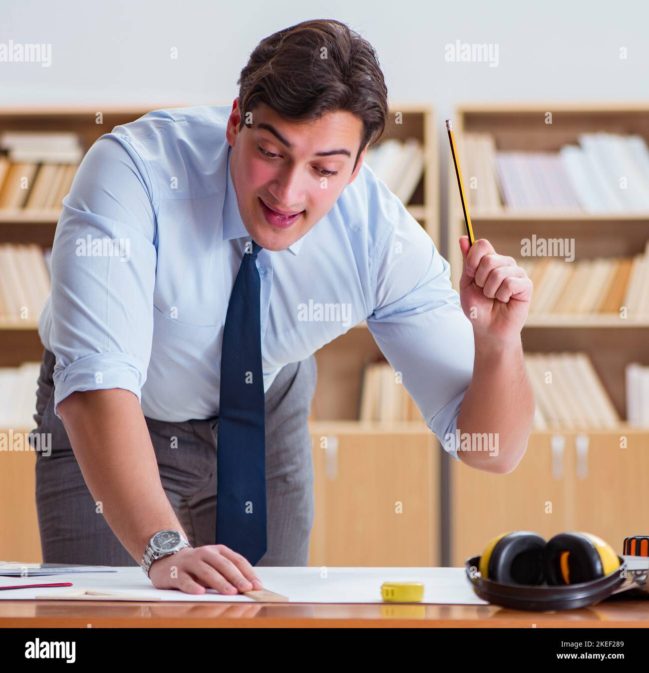 The engineer supervisor working on drawings in the office Stock Photo ...