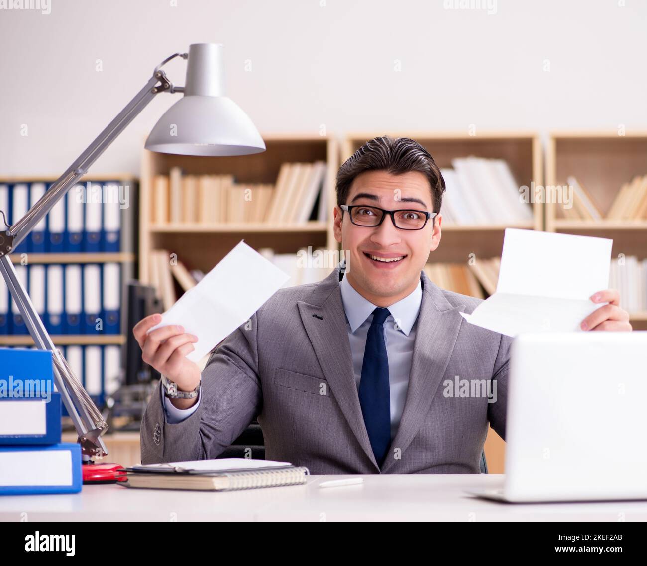 The businessman receiving letter in the office Stock Photo - Alamy