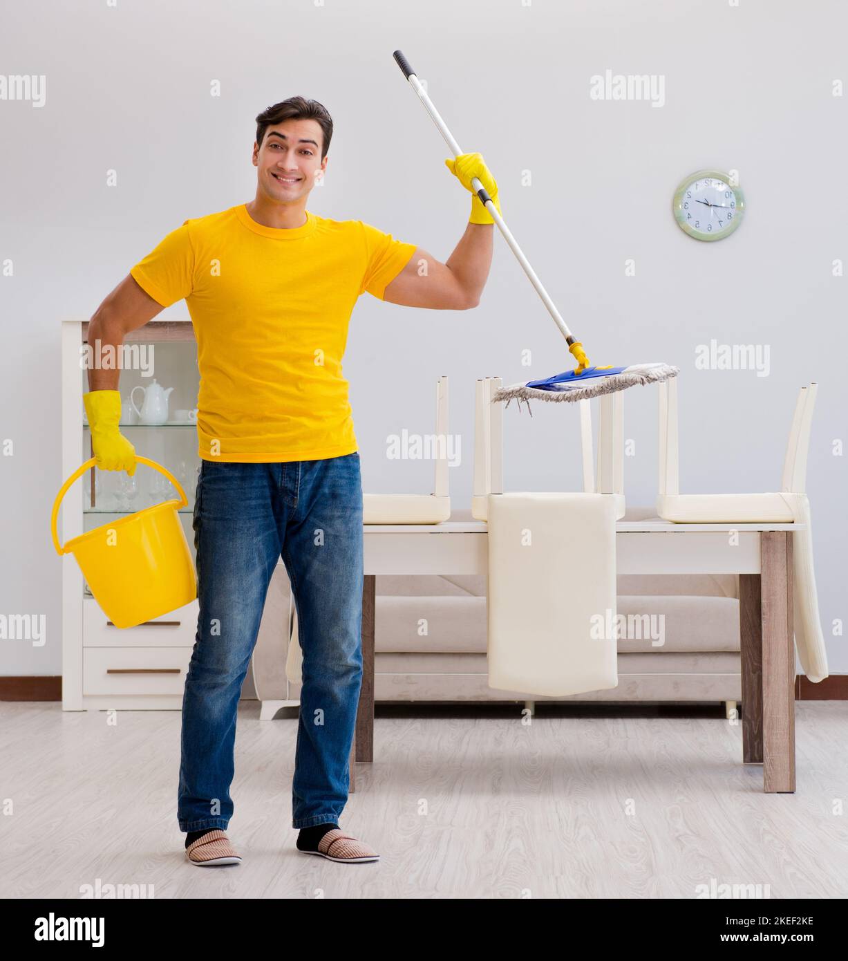 The man cleaning the house helping his wife Stock Photo - Alamy