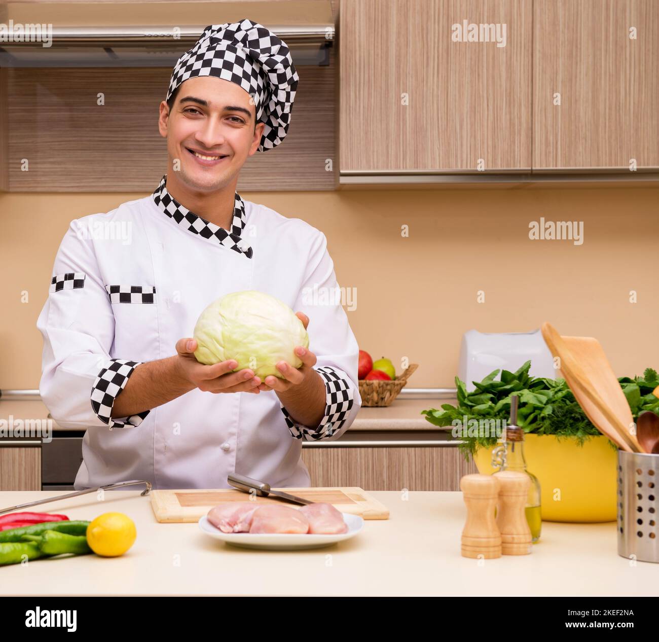 The young chef working in the kitchen Stock Photo - Alamy